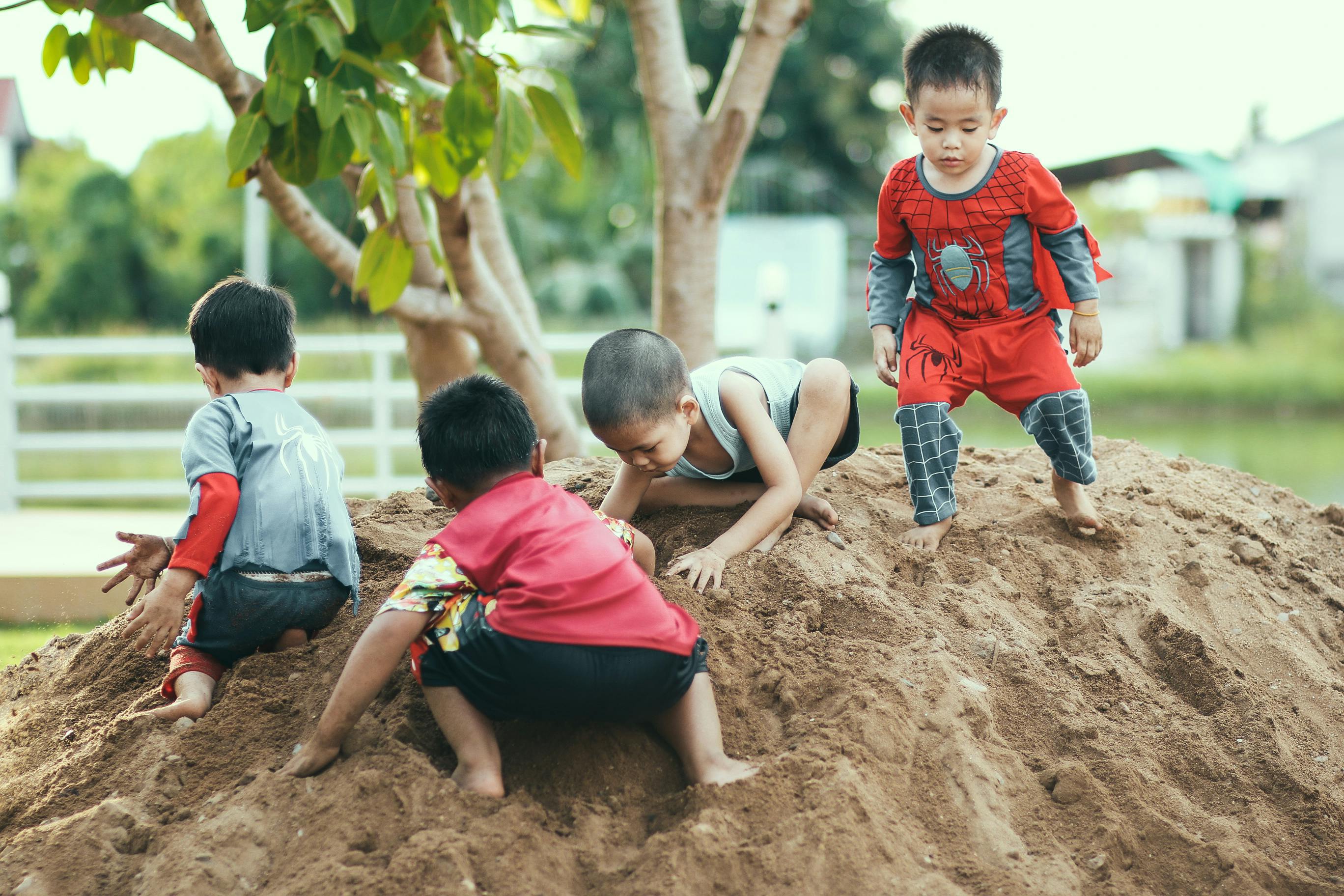 Kids Playing on Brown Sad · Free Stock Photo