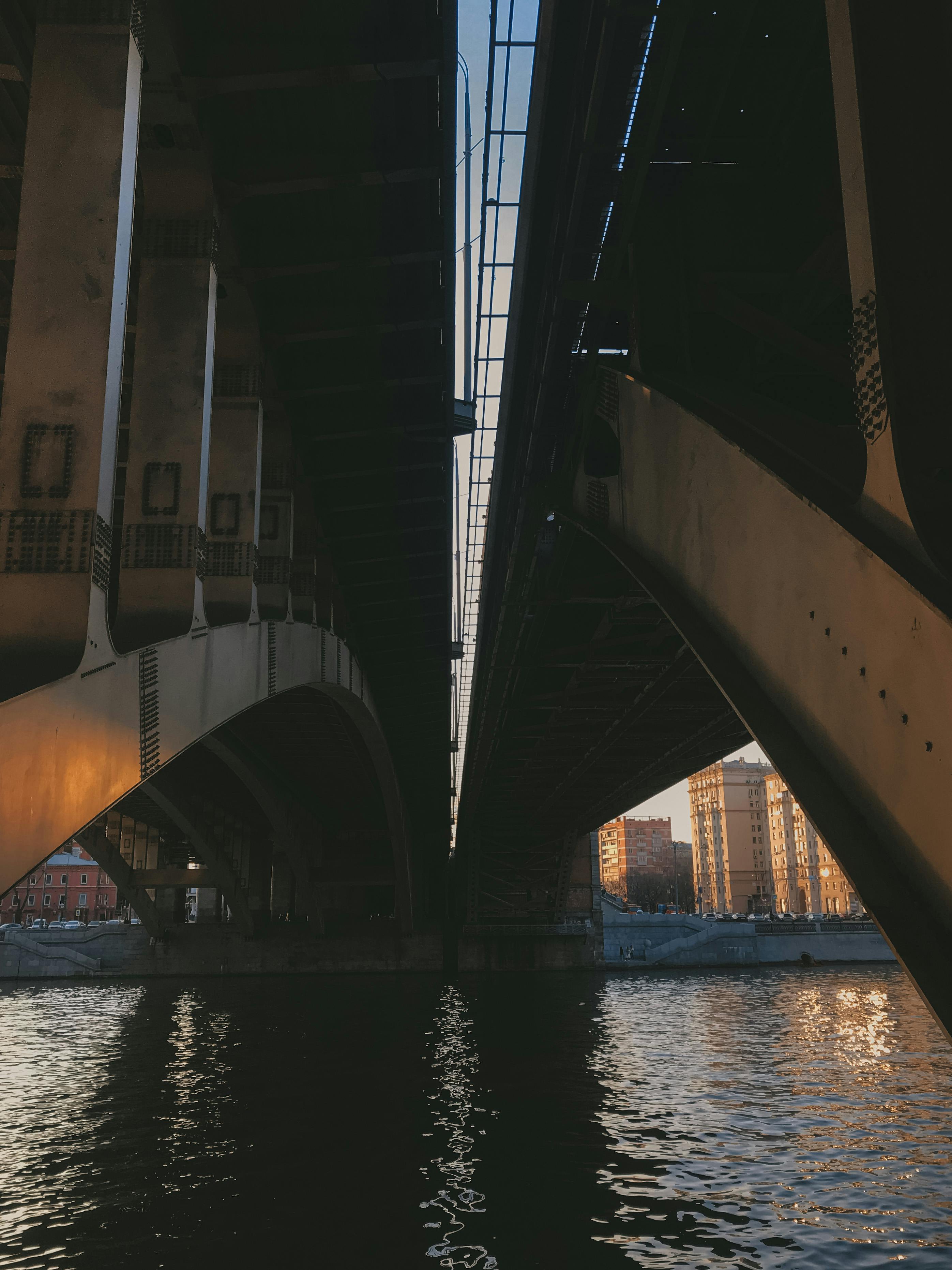 Grey Concrete Bridge Above Water Under Blue Sky · Free Stock Photo