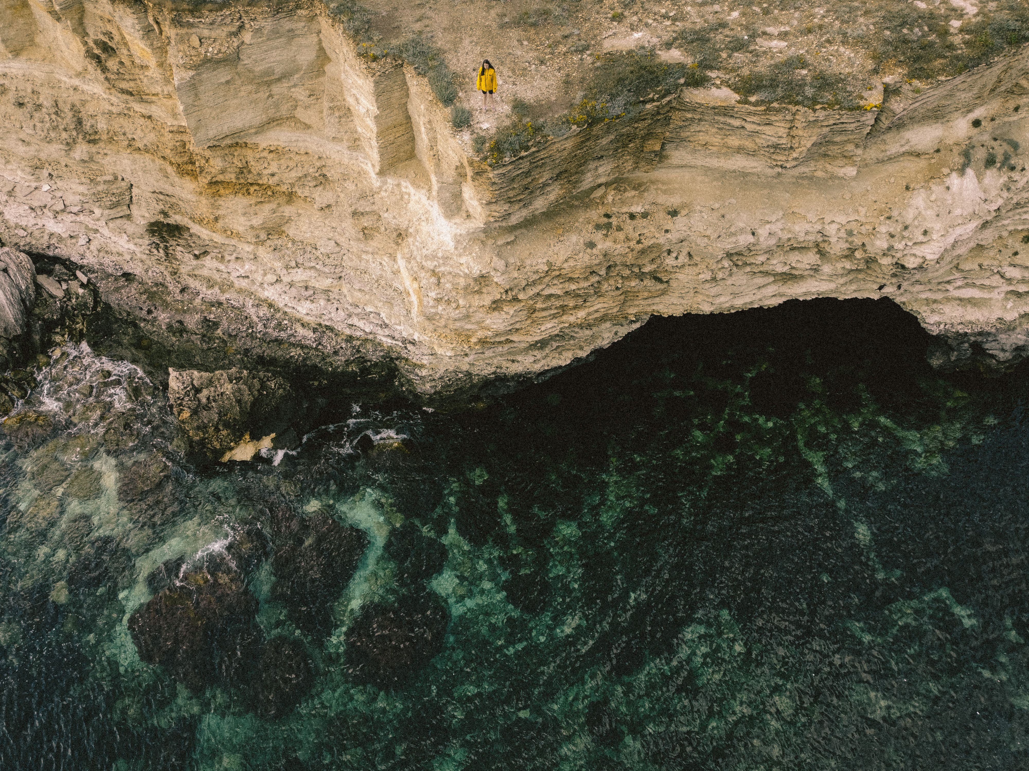 Photo of Person Standing on Cliff Edge · Free Stock Photo