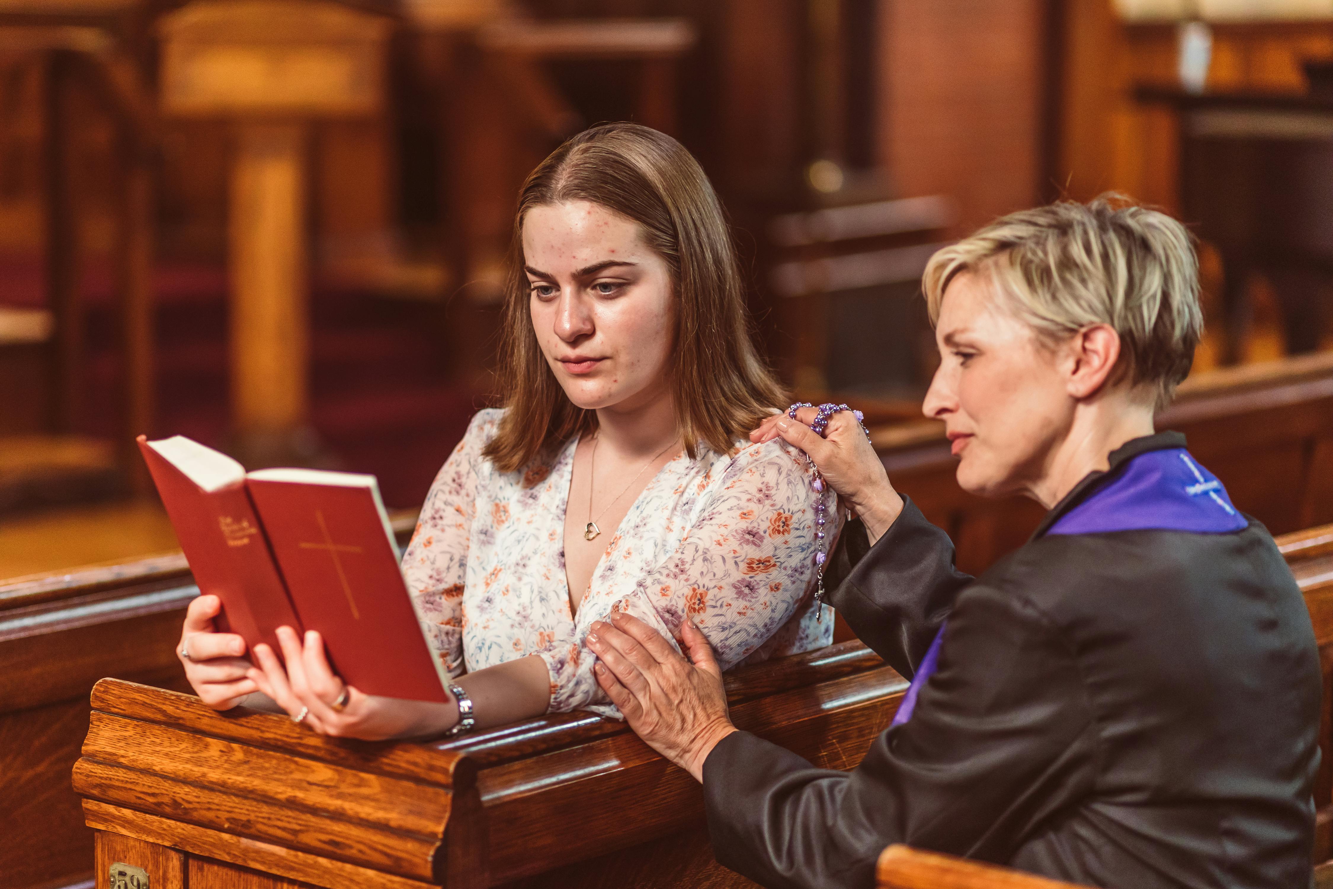 Portrait of a Female Pastor Holding Holy Bible · Free Stock Photo