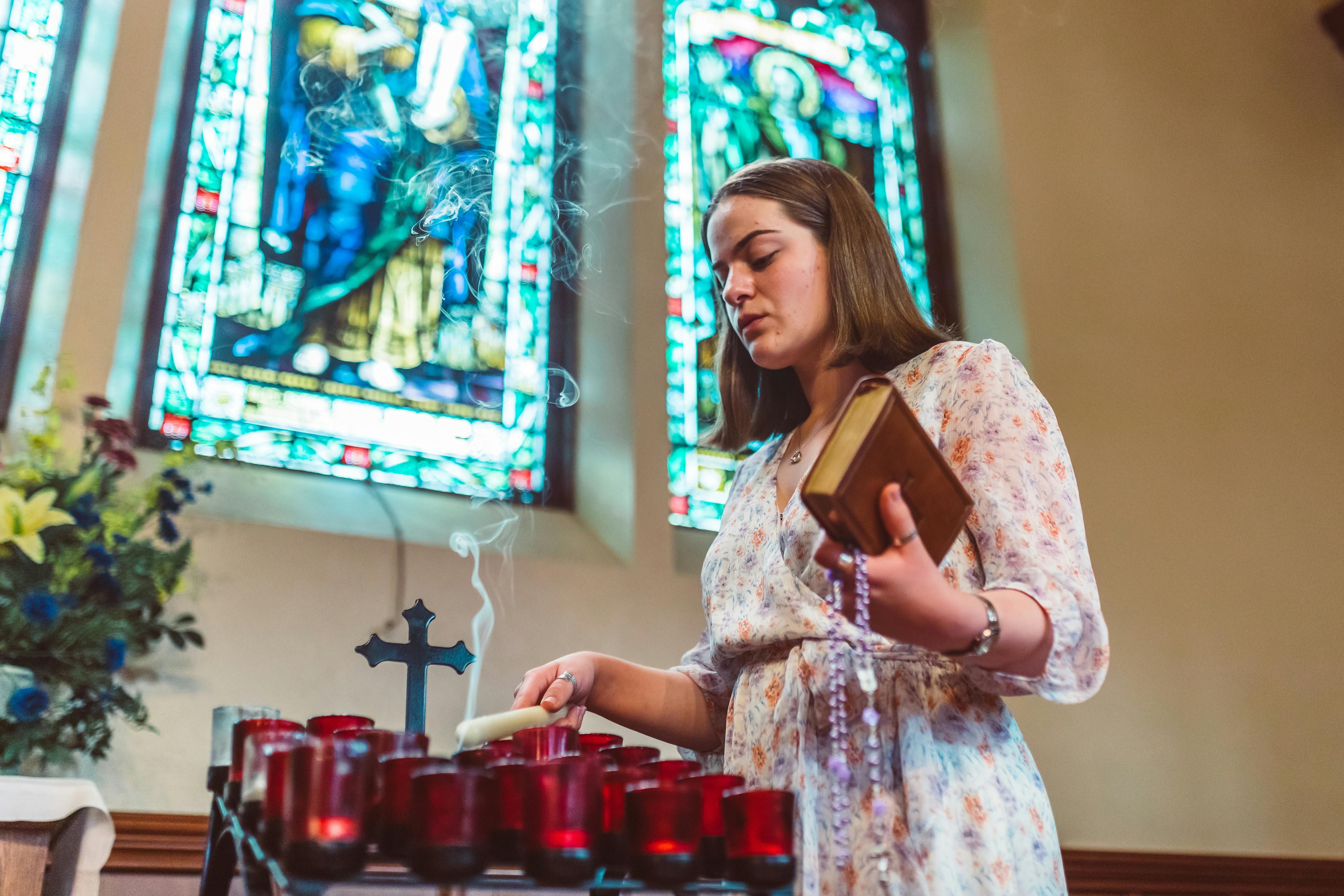 Woman Lighting Up Candles in Church · Free Stock Photo