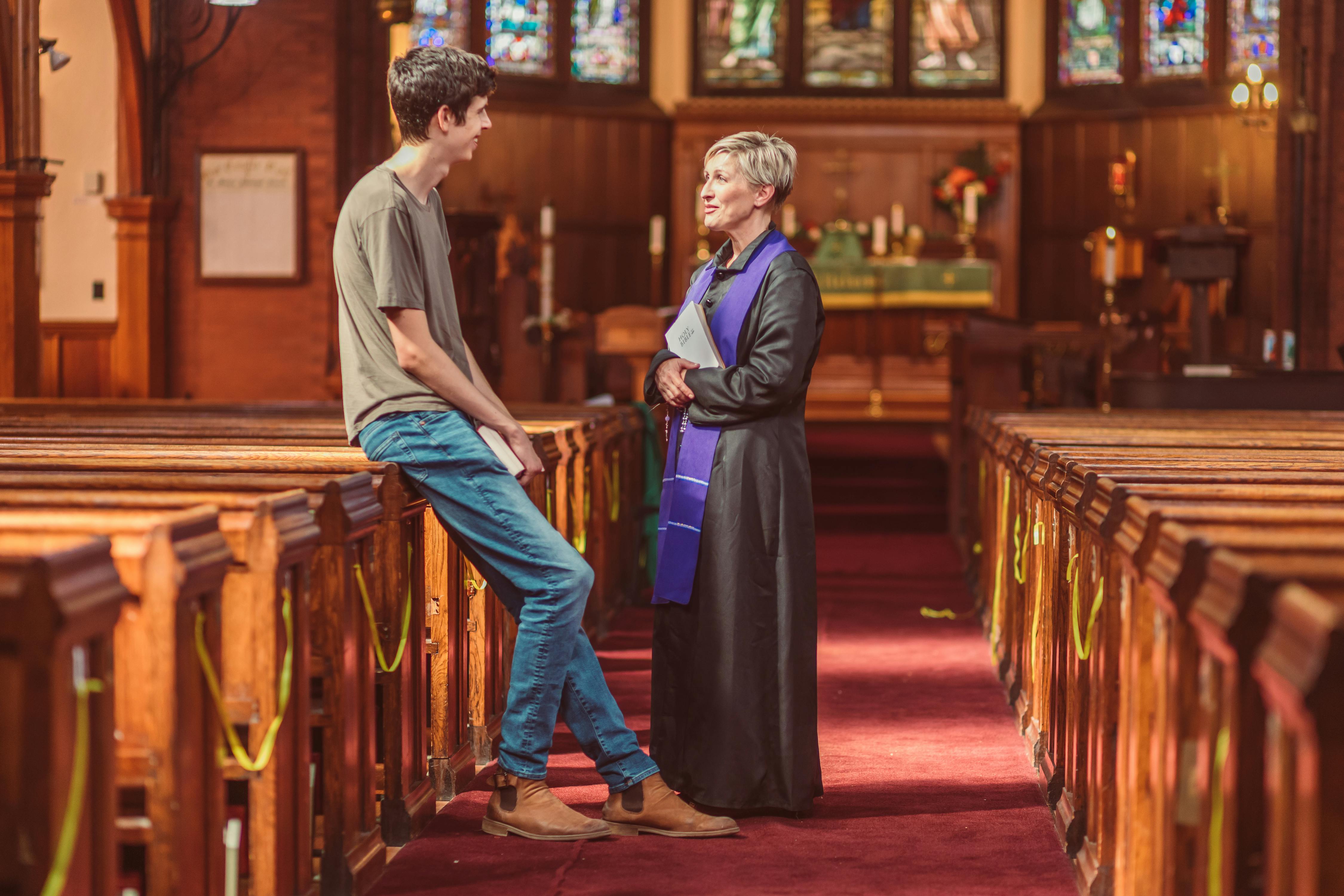 Female Priest Talking to Man inside z Church · Free Stock Photo
