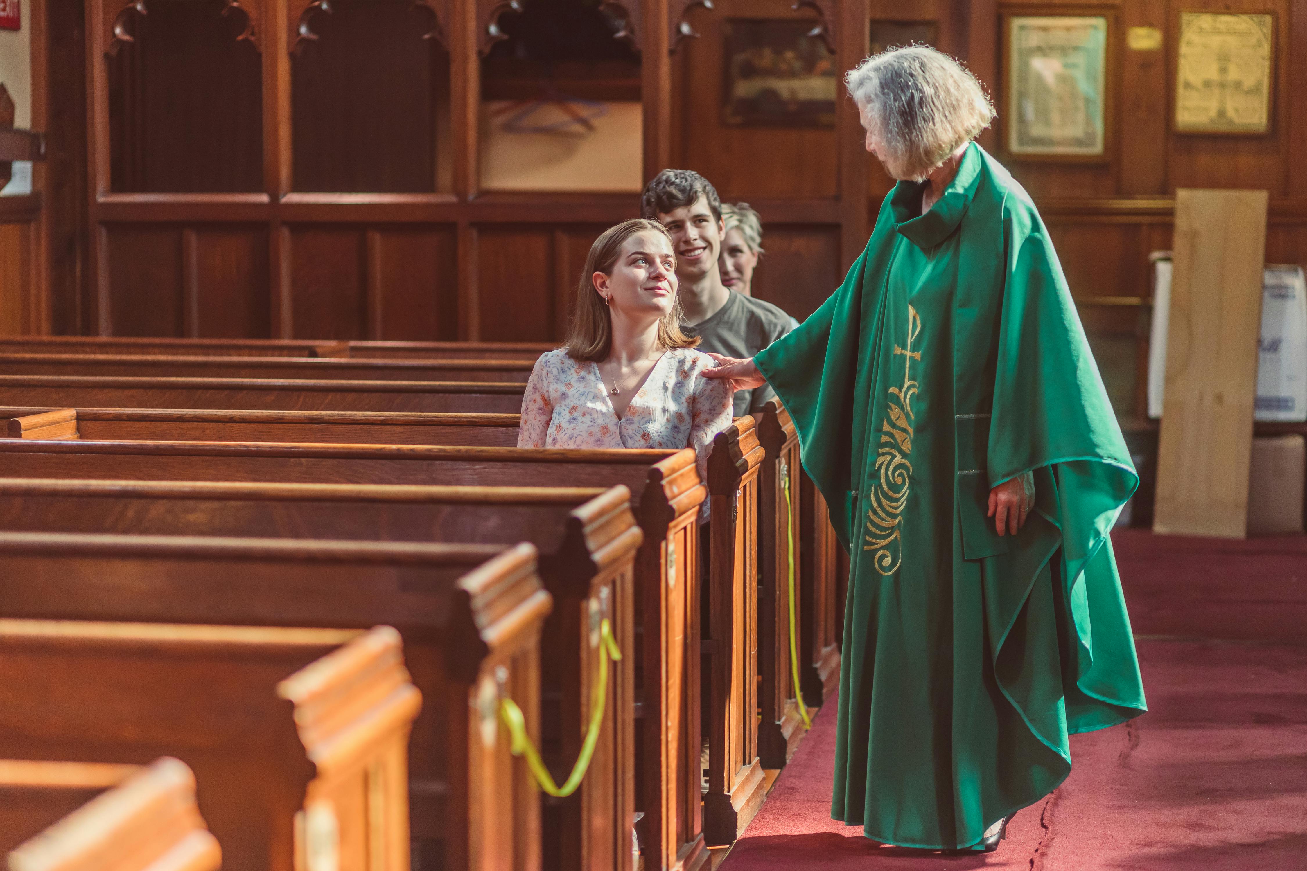 An Elderly Woman Giving Blessing To A Churchgoer · Free Stock Photo