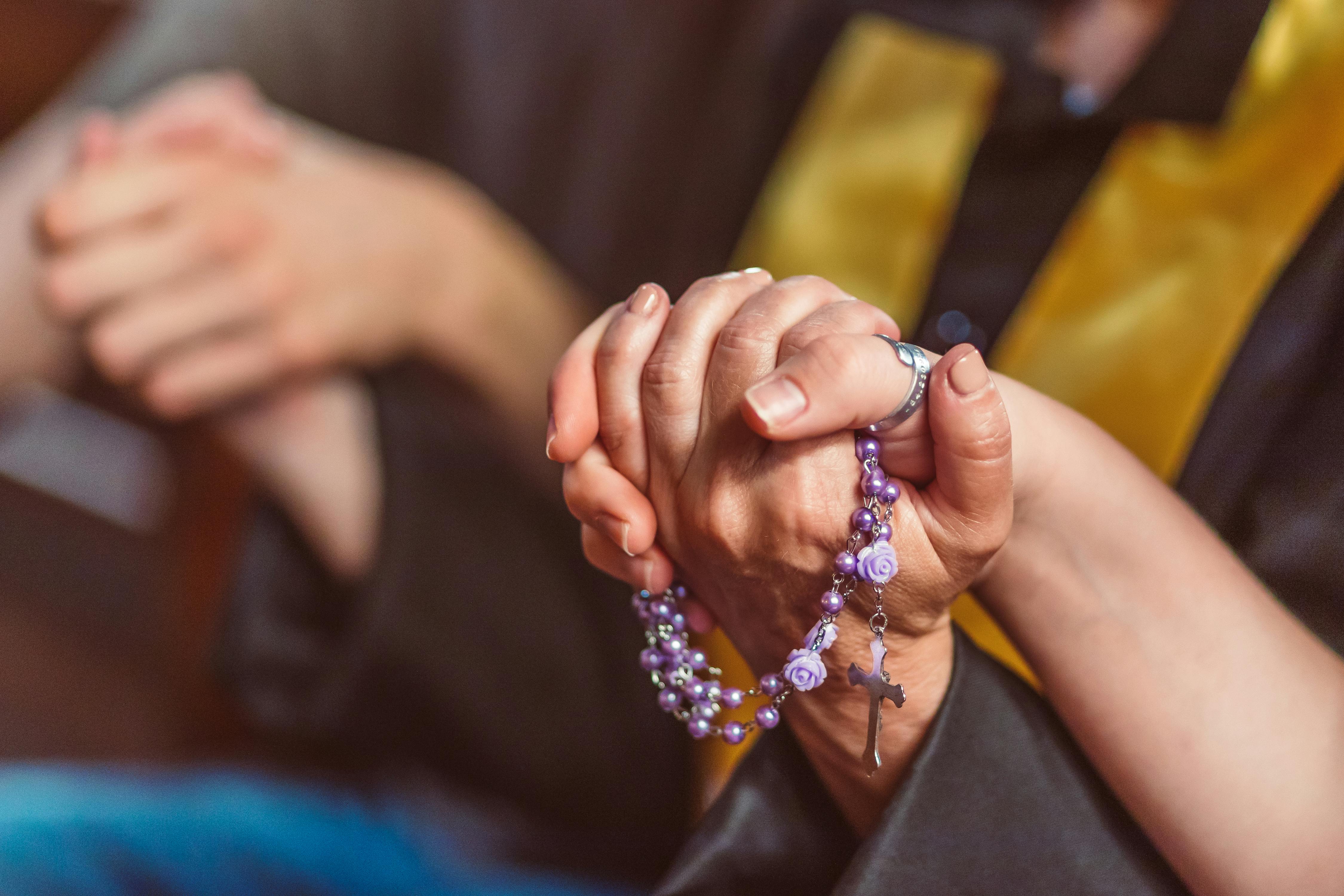 Close-up of Holding Hands While Holding Rosary · Free Stock Photo