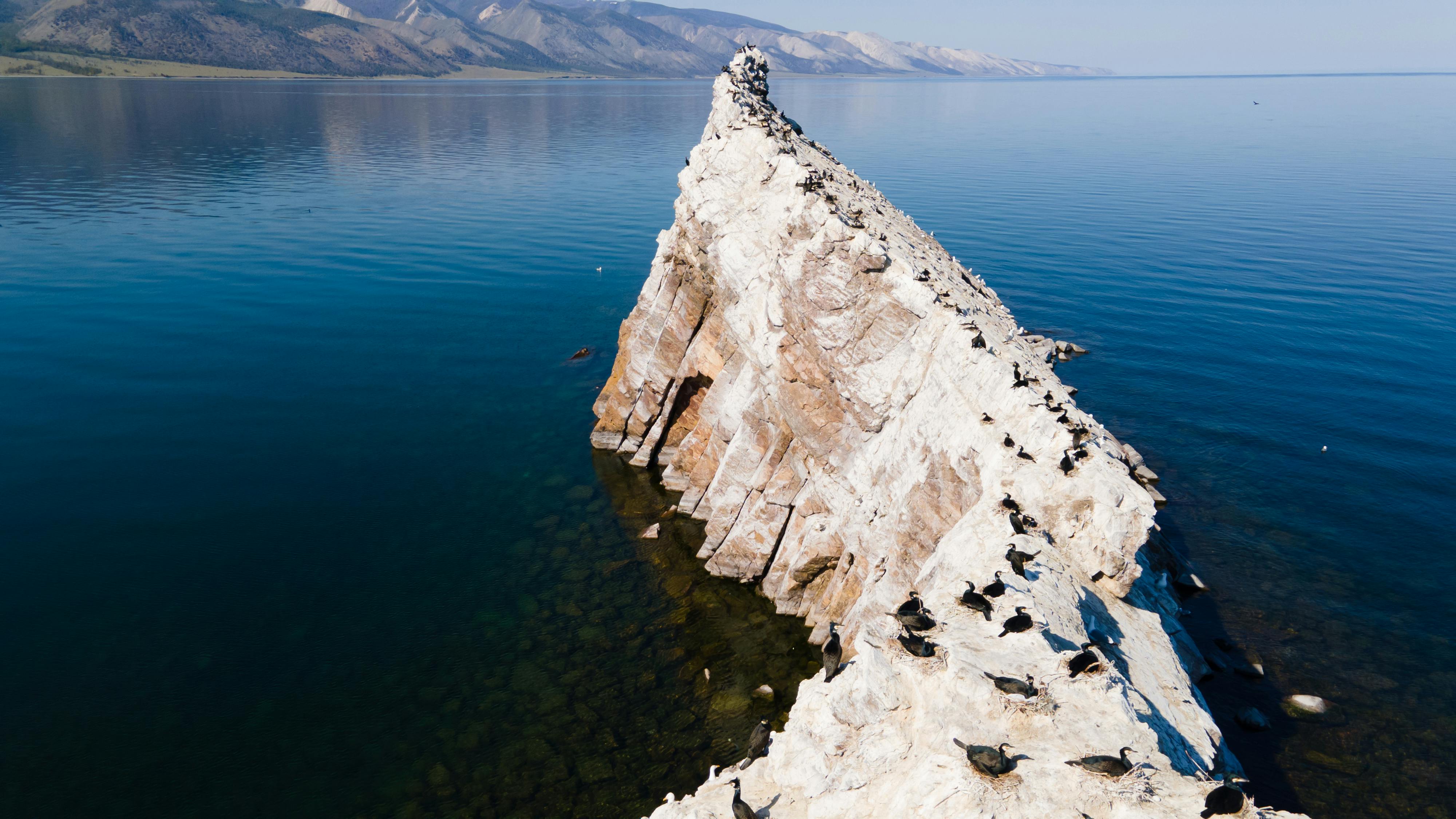 White Rock Formation on Body of Water · Free Stock Photo