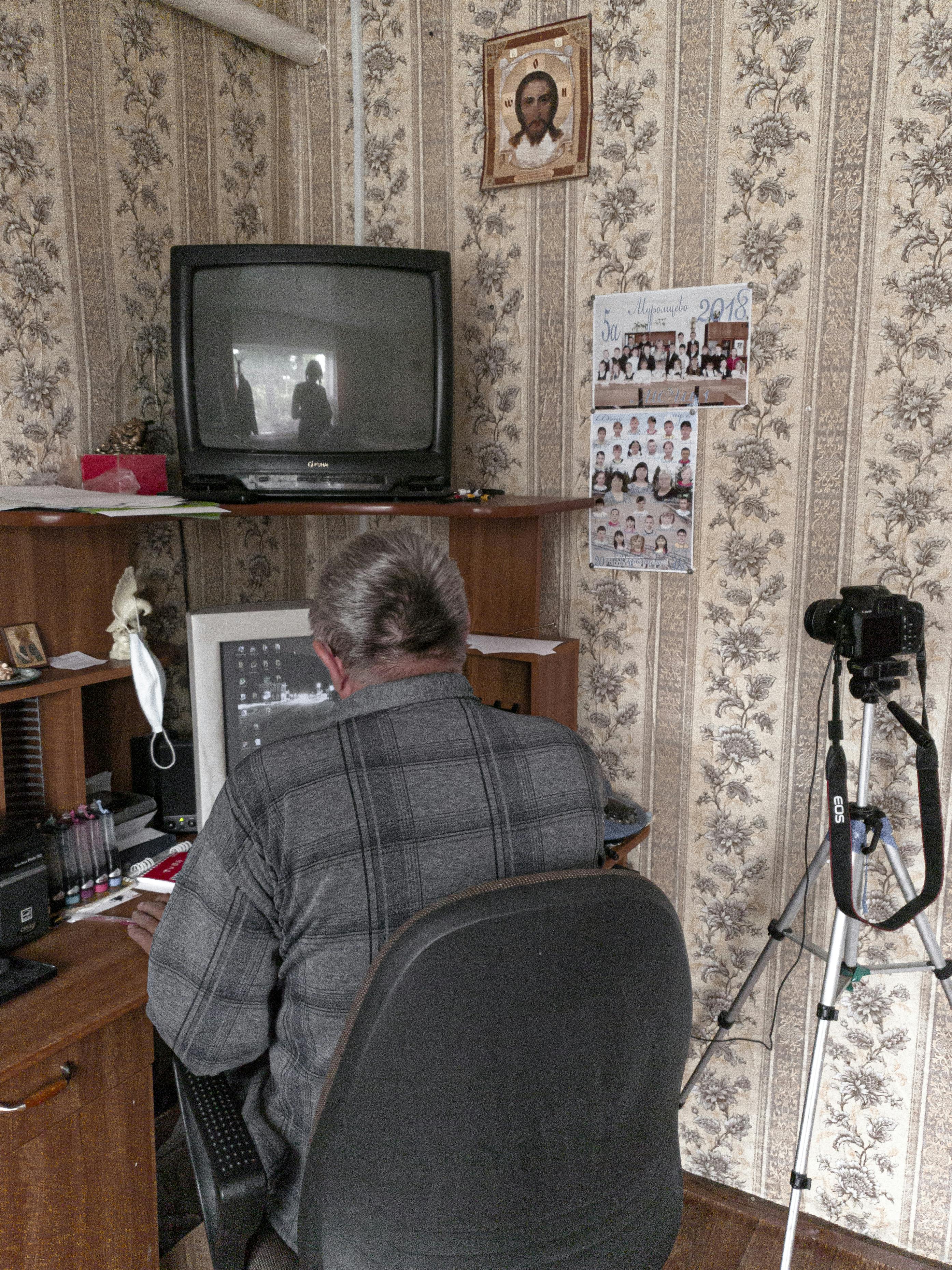 Back View of Man Sitting In Front of a Computer · Free Stock Photo
