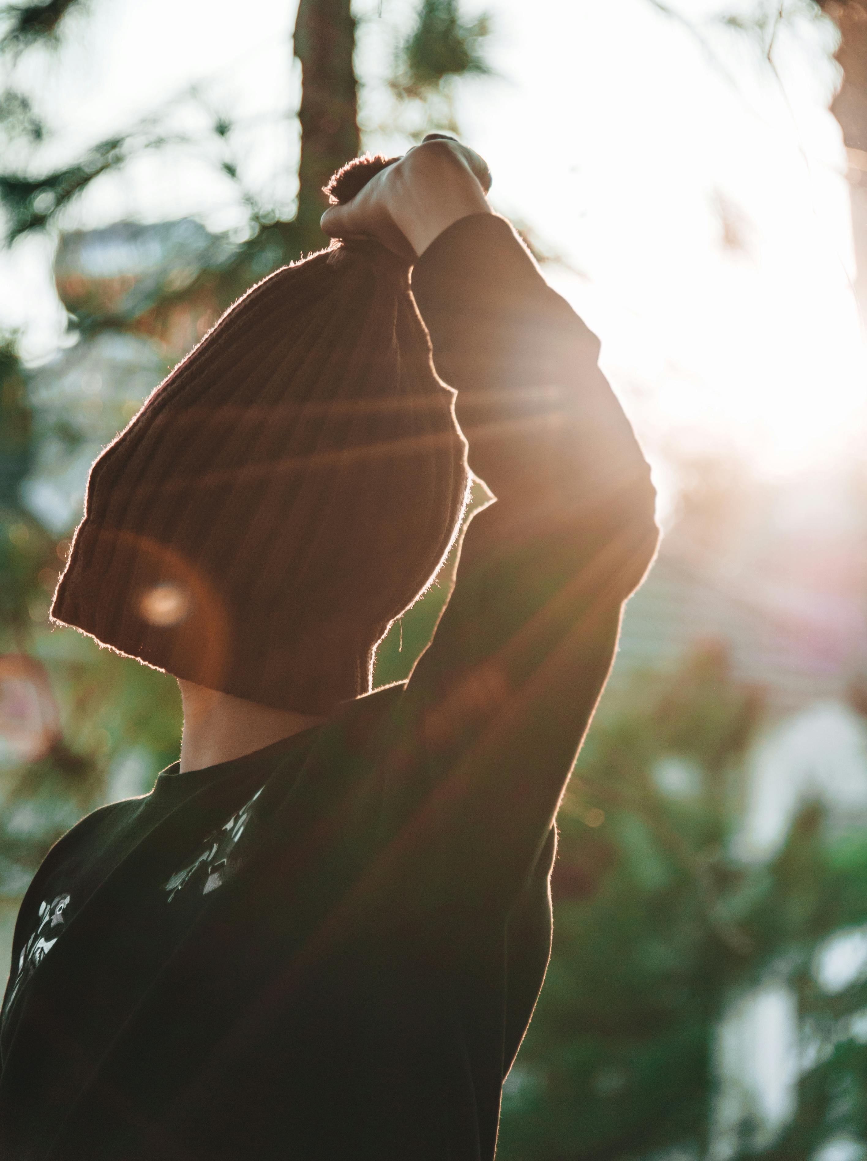 Person Covering Its Face With Knitted Hat · Free Stock Photo