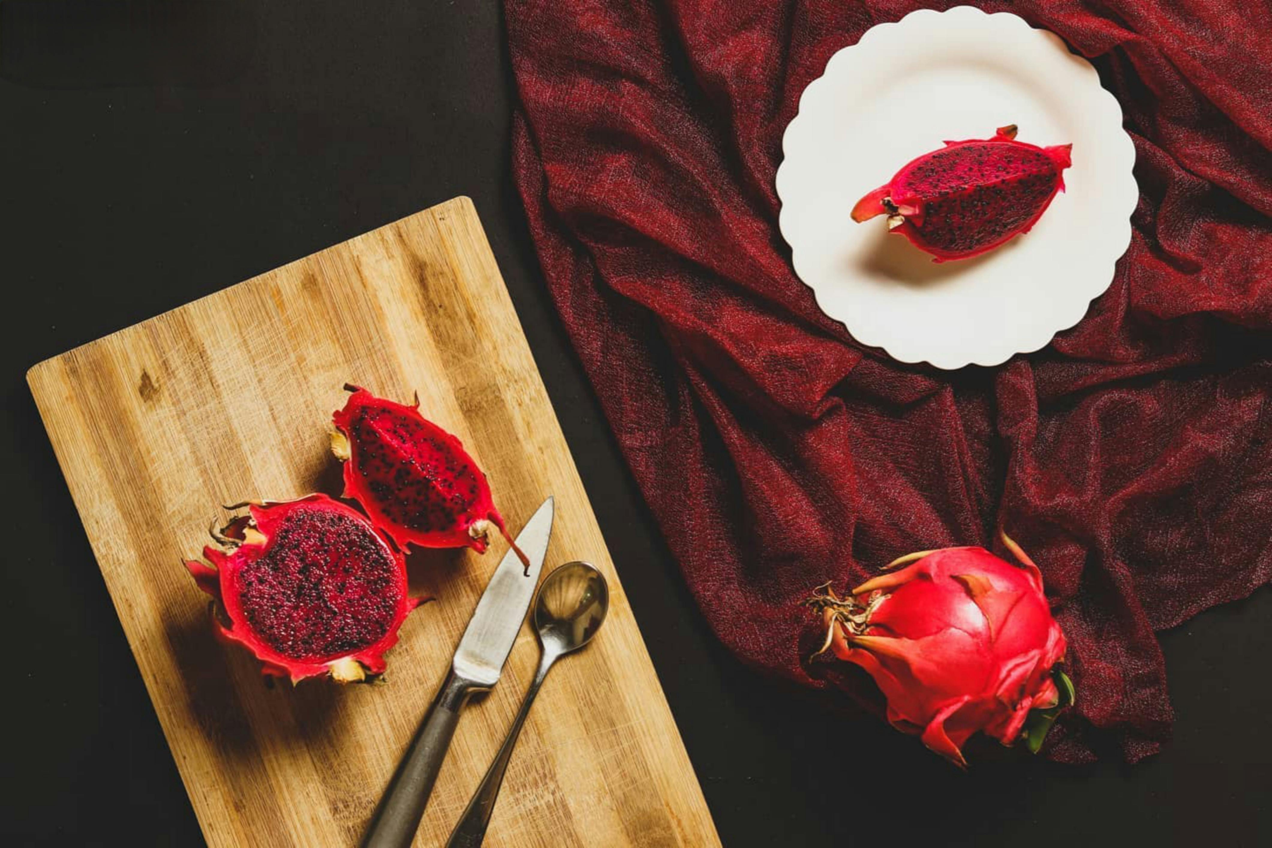 Woman Slicing a Fruit Using a Knife · Free Stock Photo