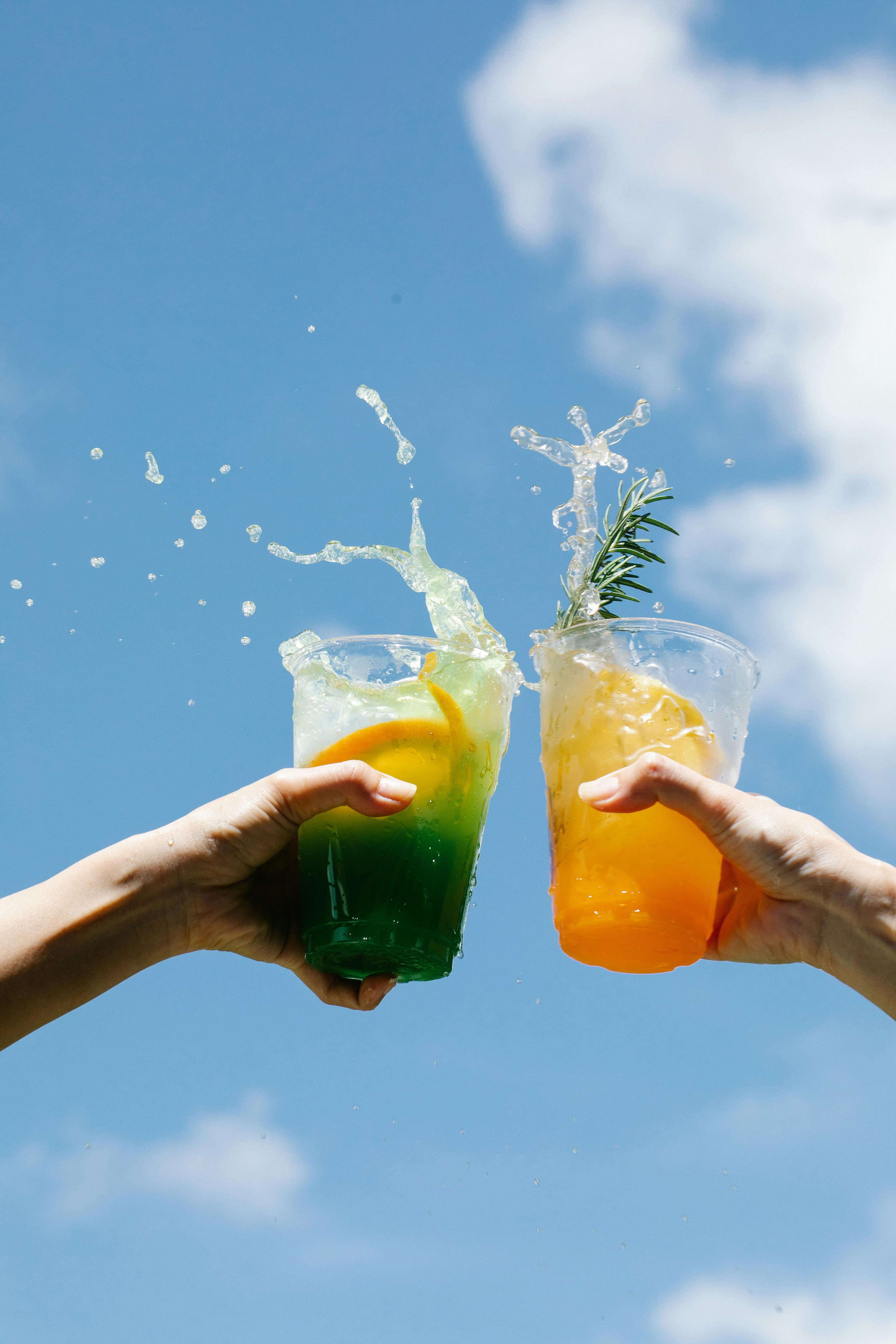 Hands Holding Drinks · Free Stock Photo