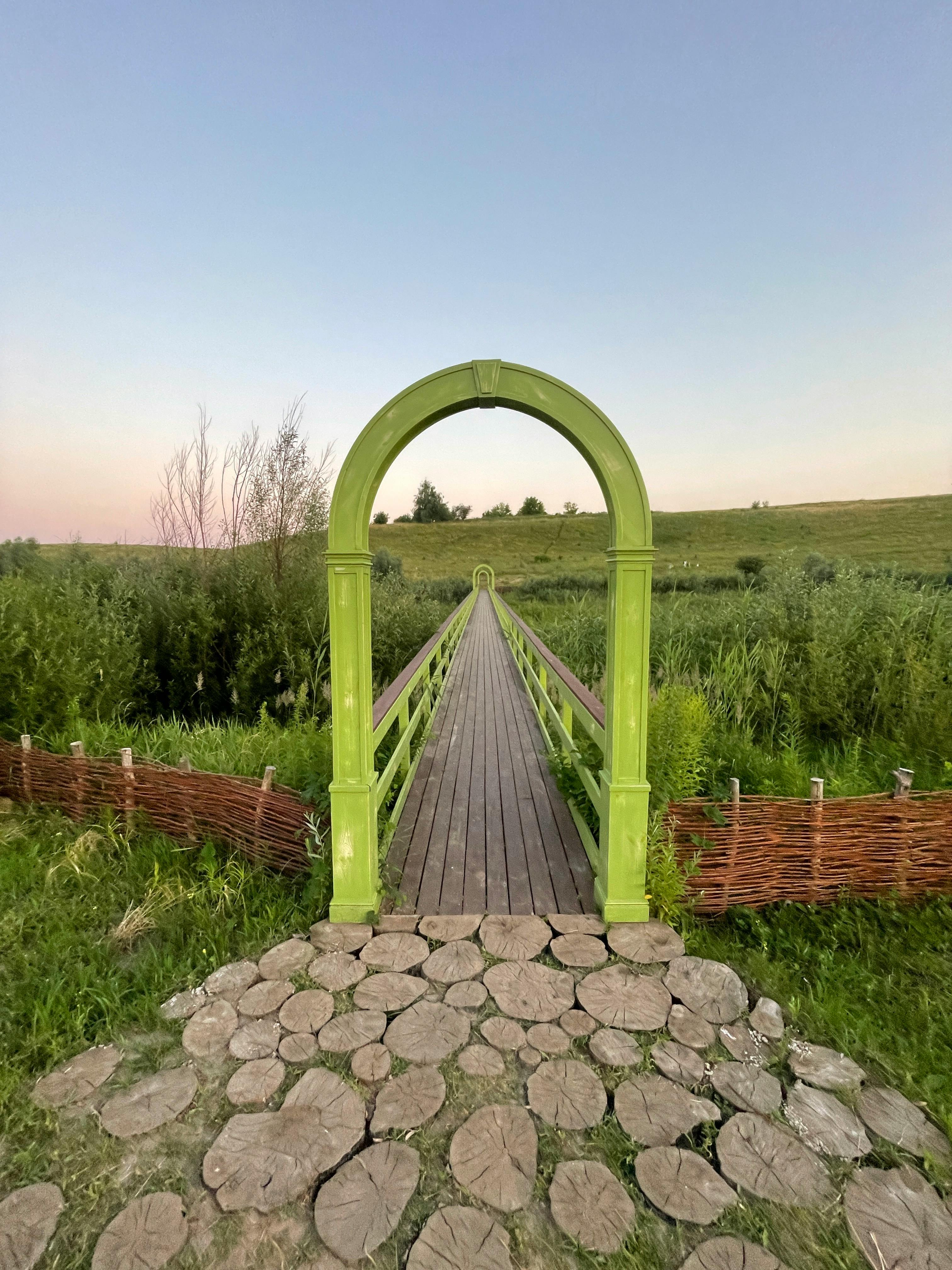 An Arched Gateway to a Wooden bridge · Free Stock Photo