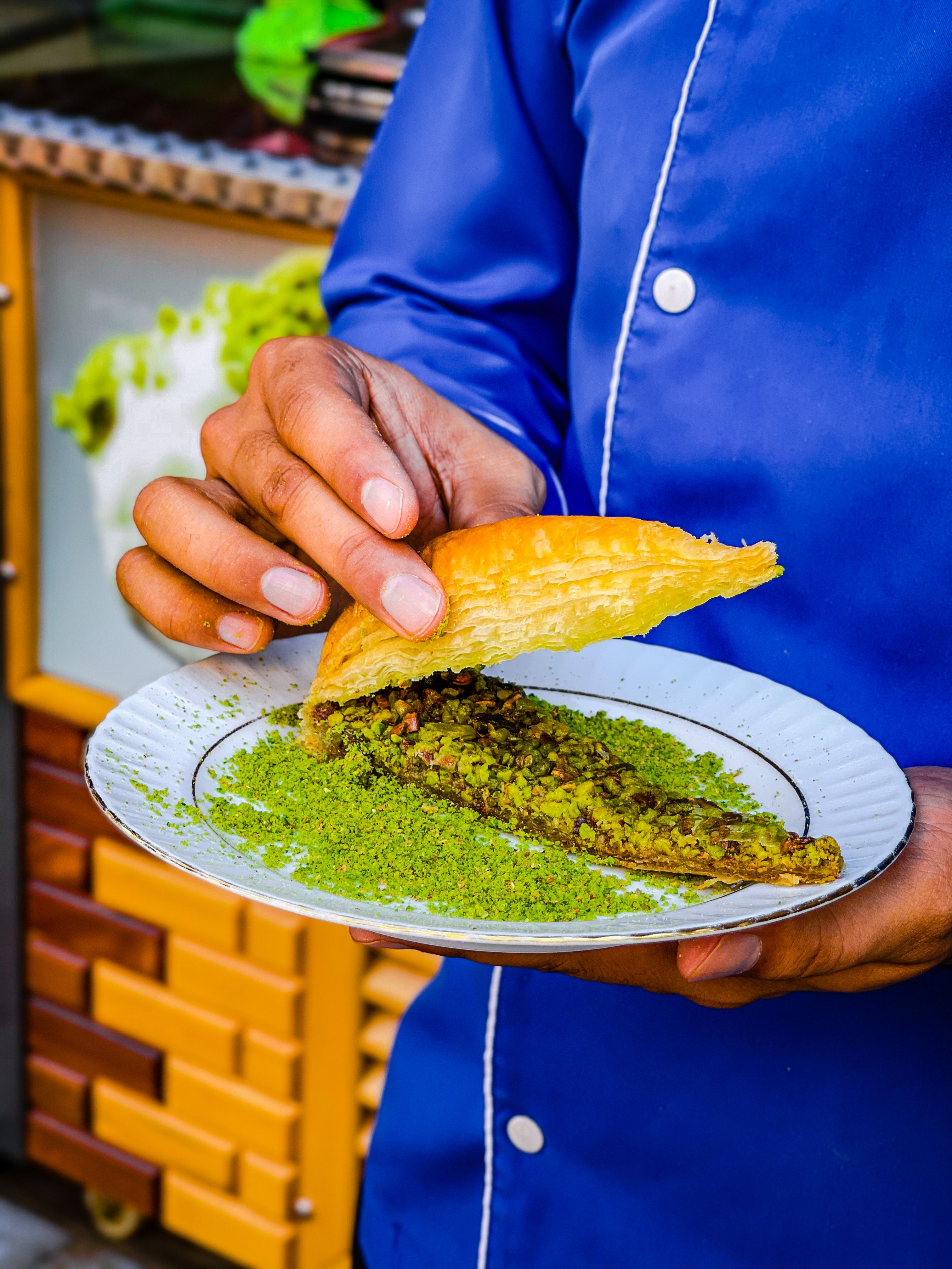 A Person Holding Food Wrapped with Paper · Free Stock Photo