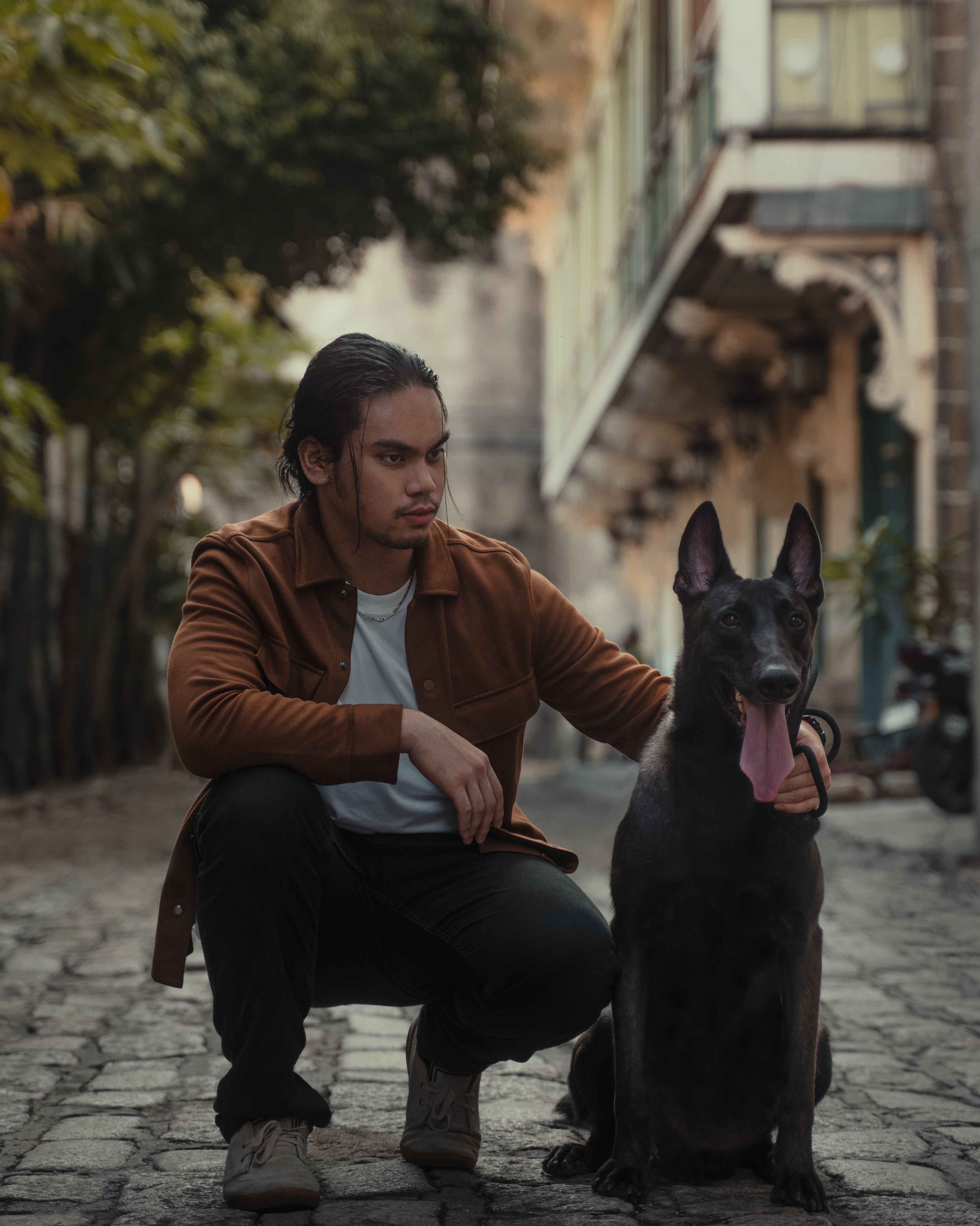 A Man Sitting with a Dog · Free Stock Photo