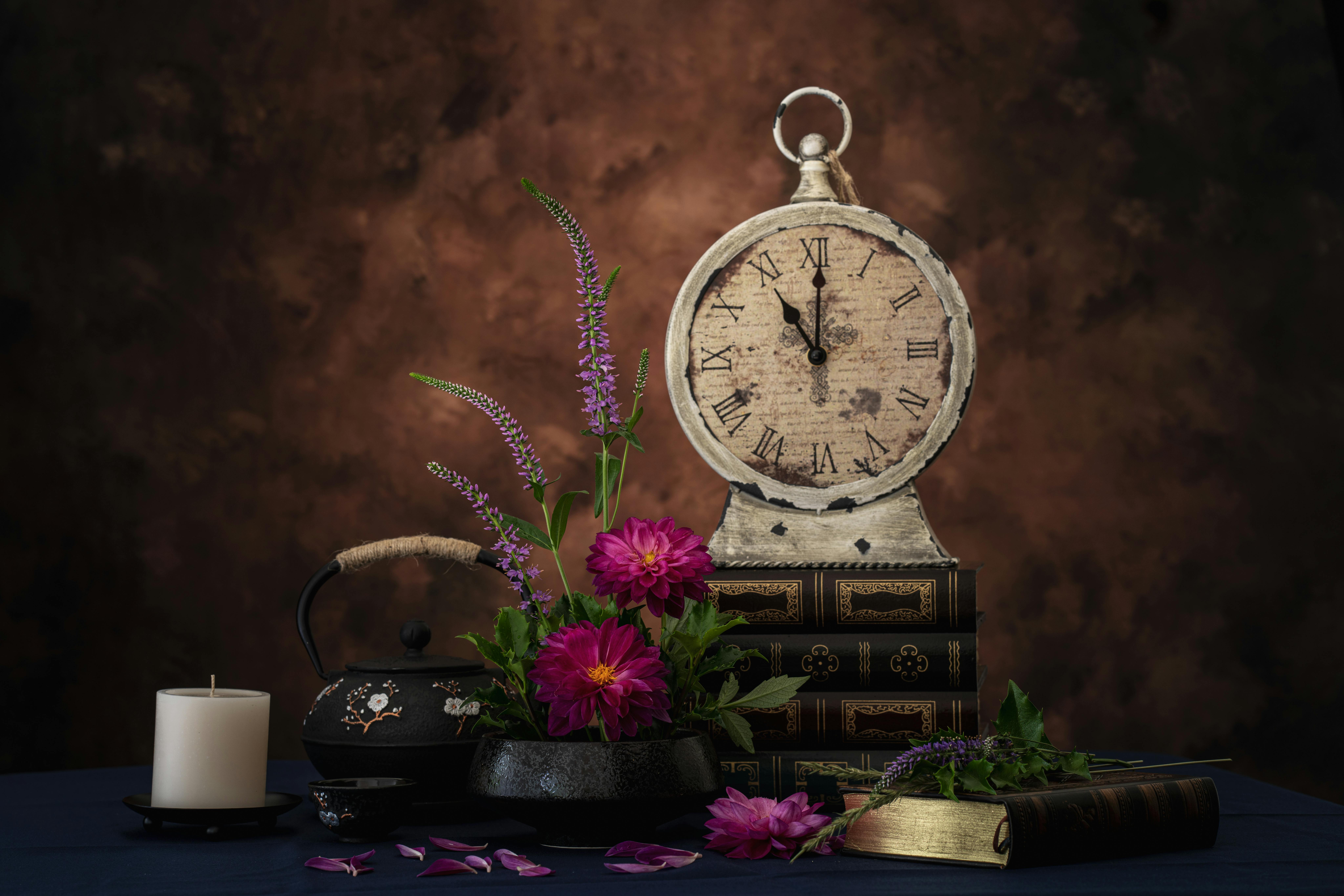 An Old Clock and Flowers on a Table · Free Stock Photo