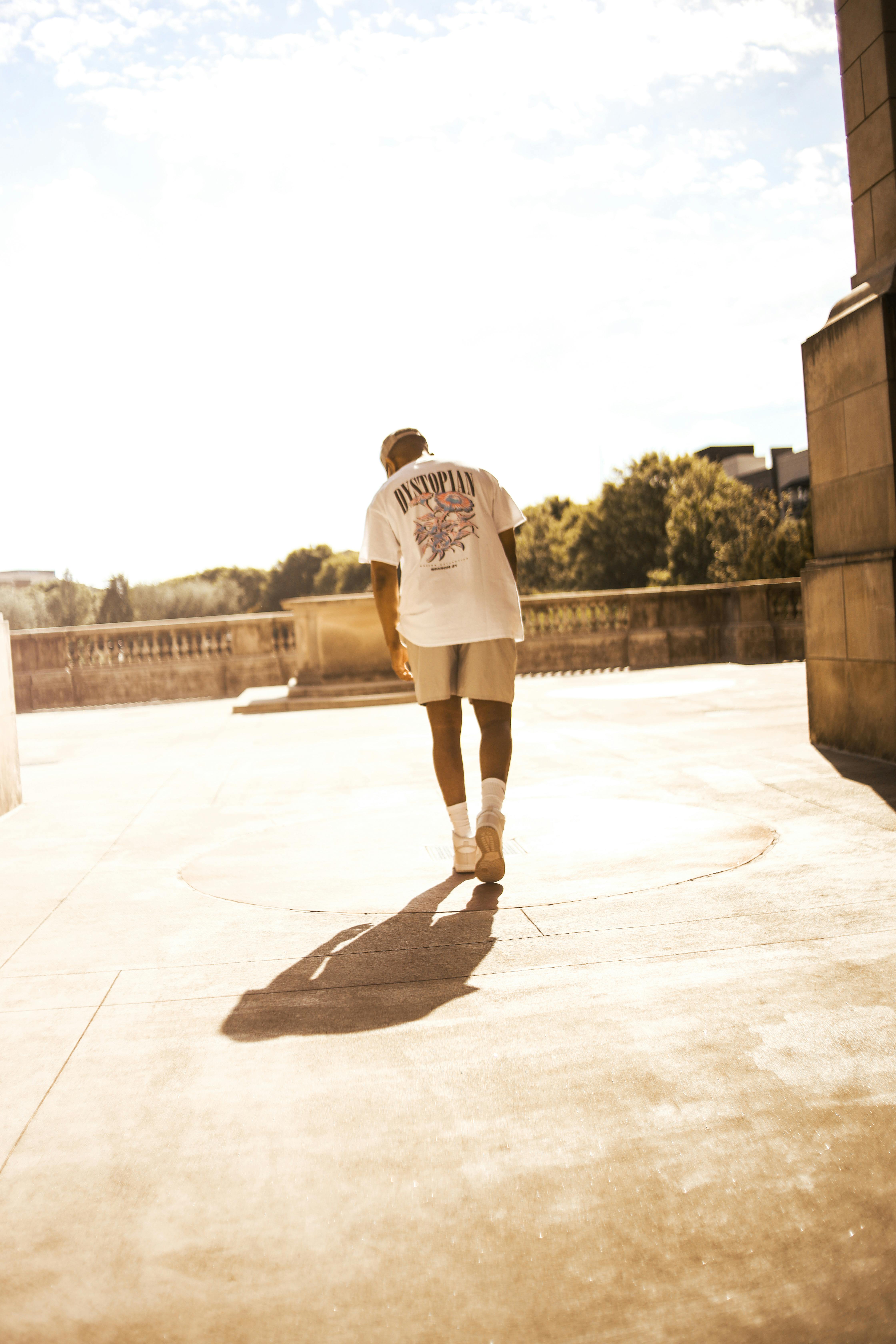 Back View of a Man in Streetwear Walking · Free Stock Photo