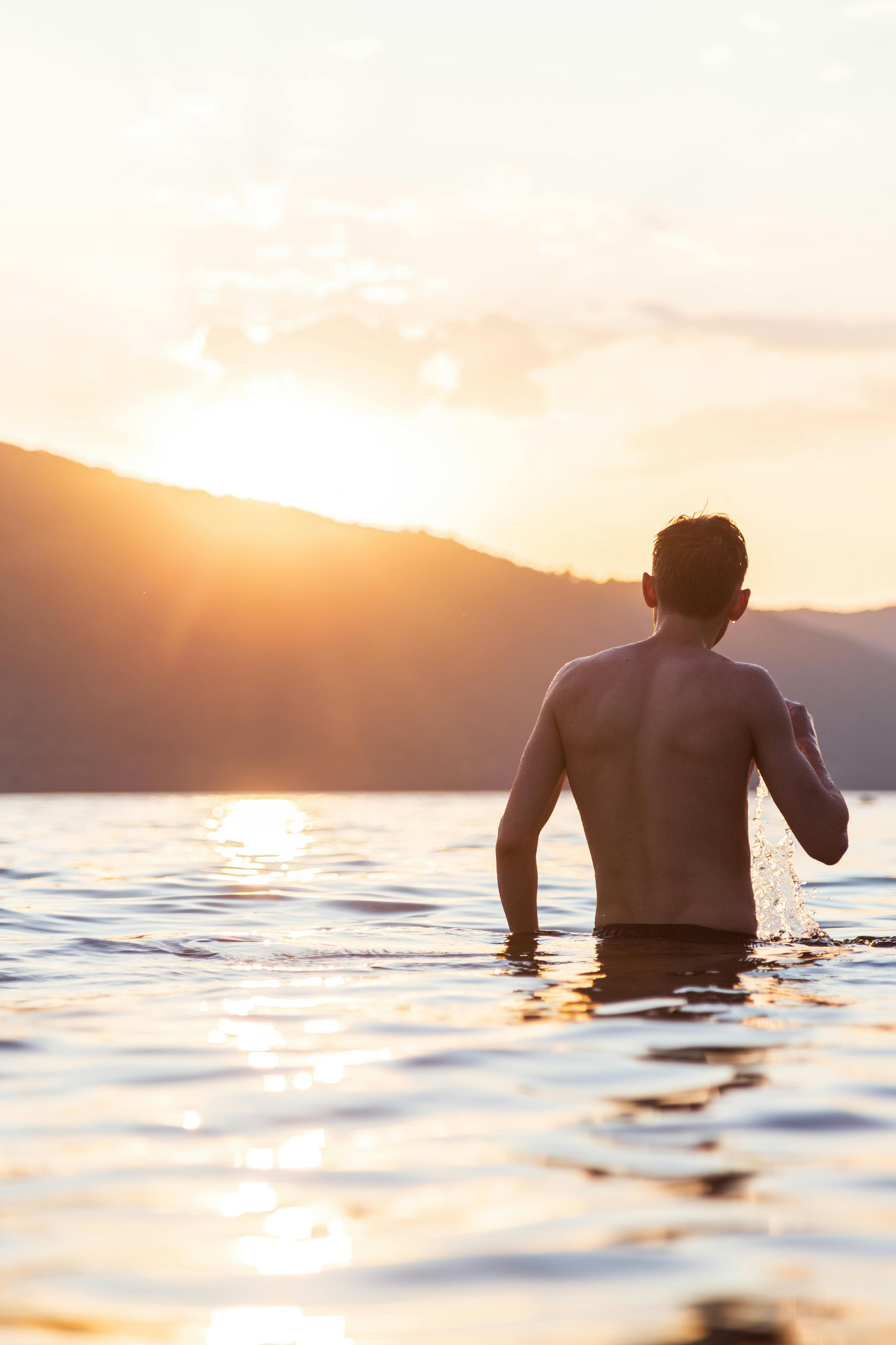 Plants around Man Standing in Sunset Sunlight · Free Stock Photo
