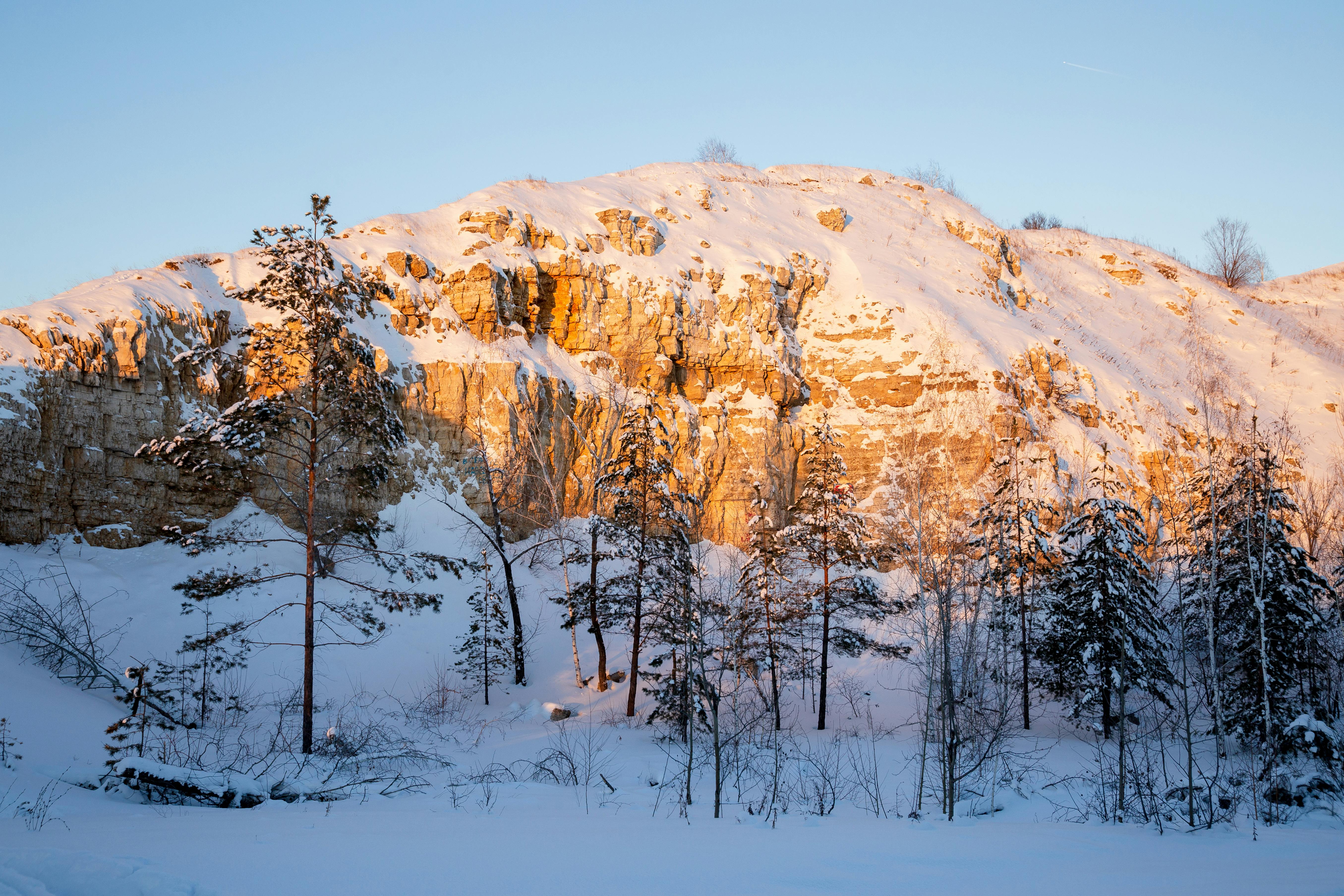 Grey Mountain Filled With Snow Under Grey Sky · Free Stock Photo