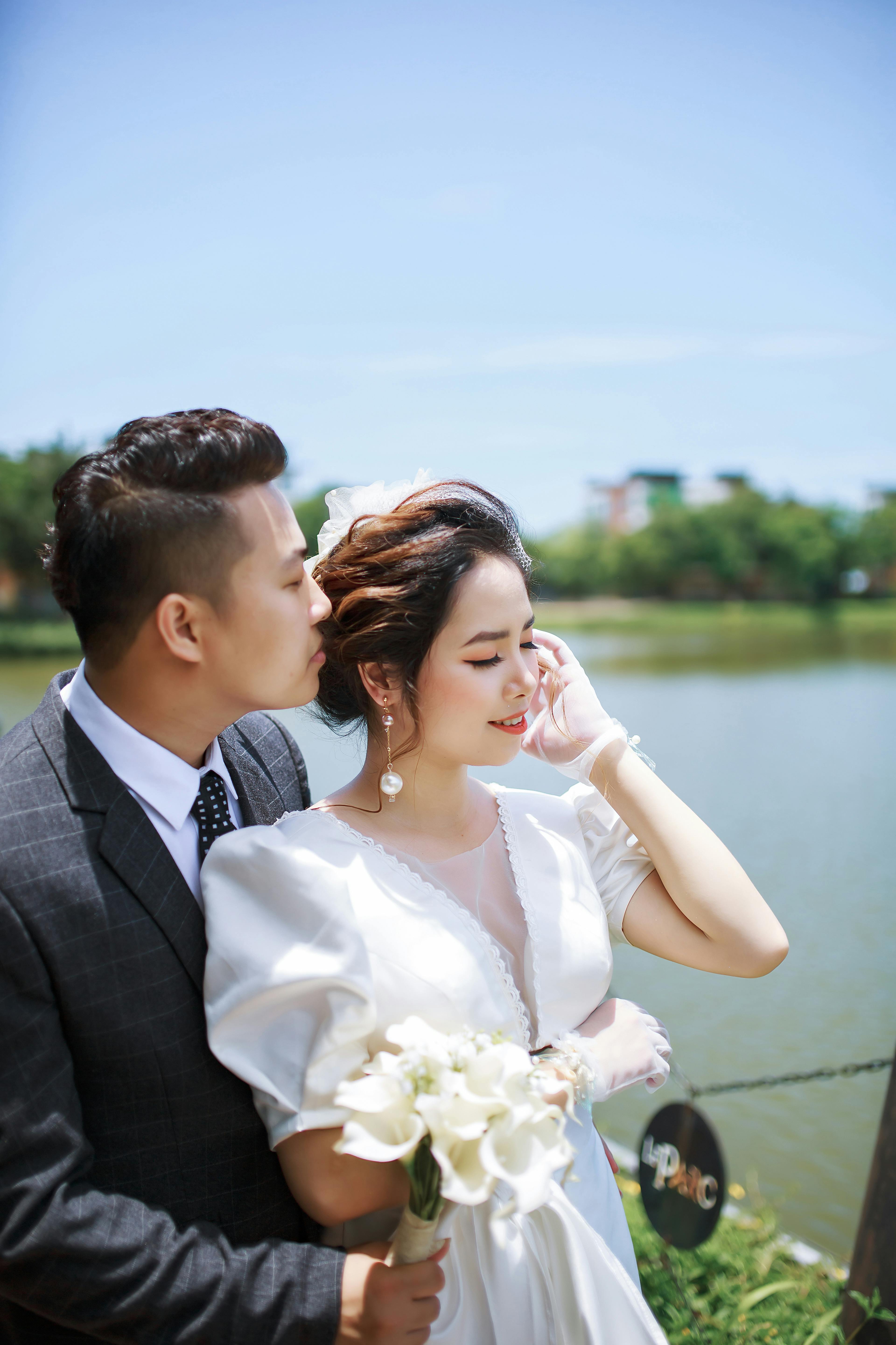 Back View of a Romantic Wedding Couple on the Dock · Free Stock Photo