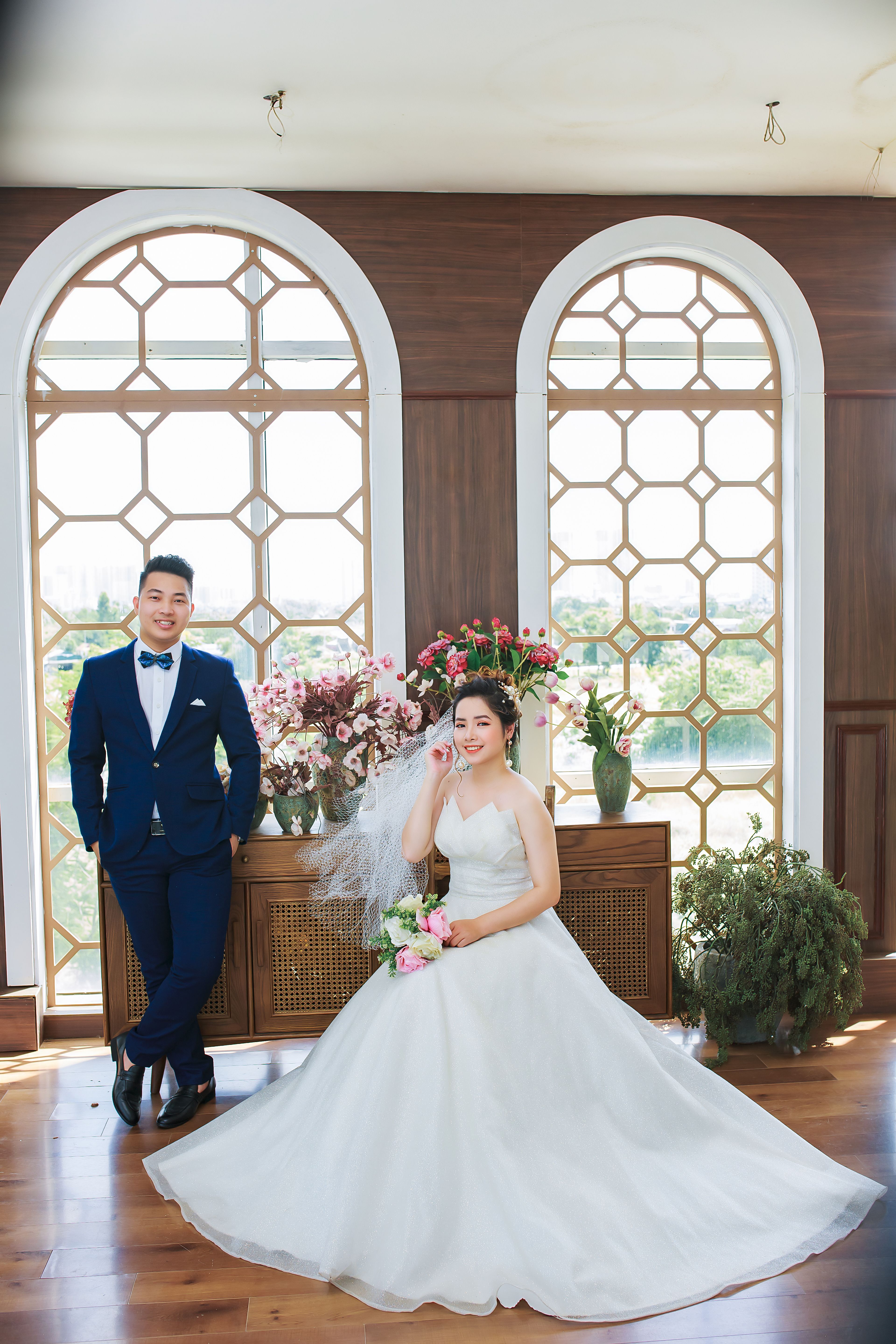 A bride and groom standing under a canopy · Free Stock Photo