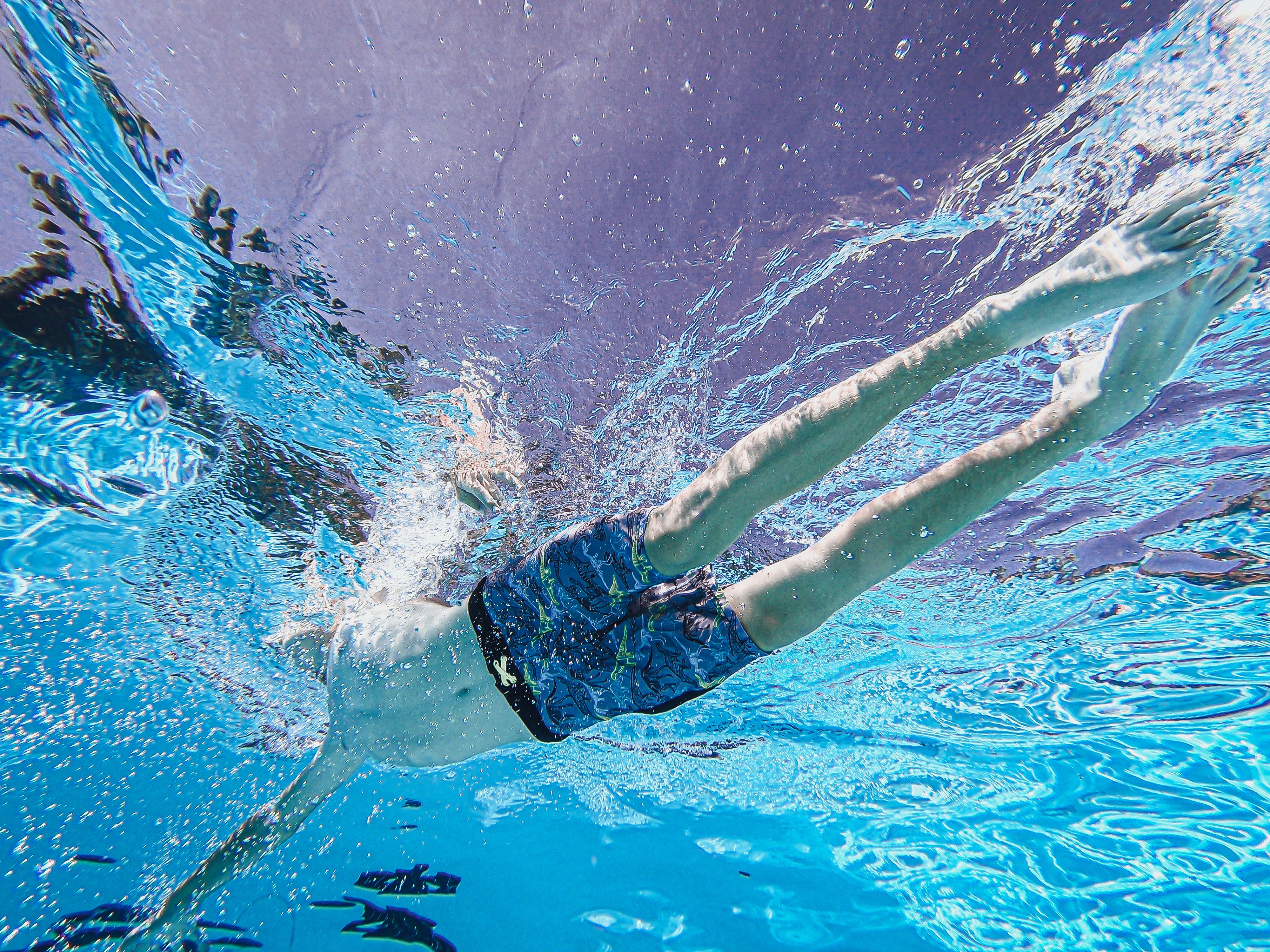 Person Swimming on Body of Water · Free Stock Photo