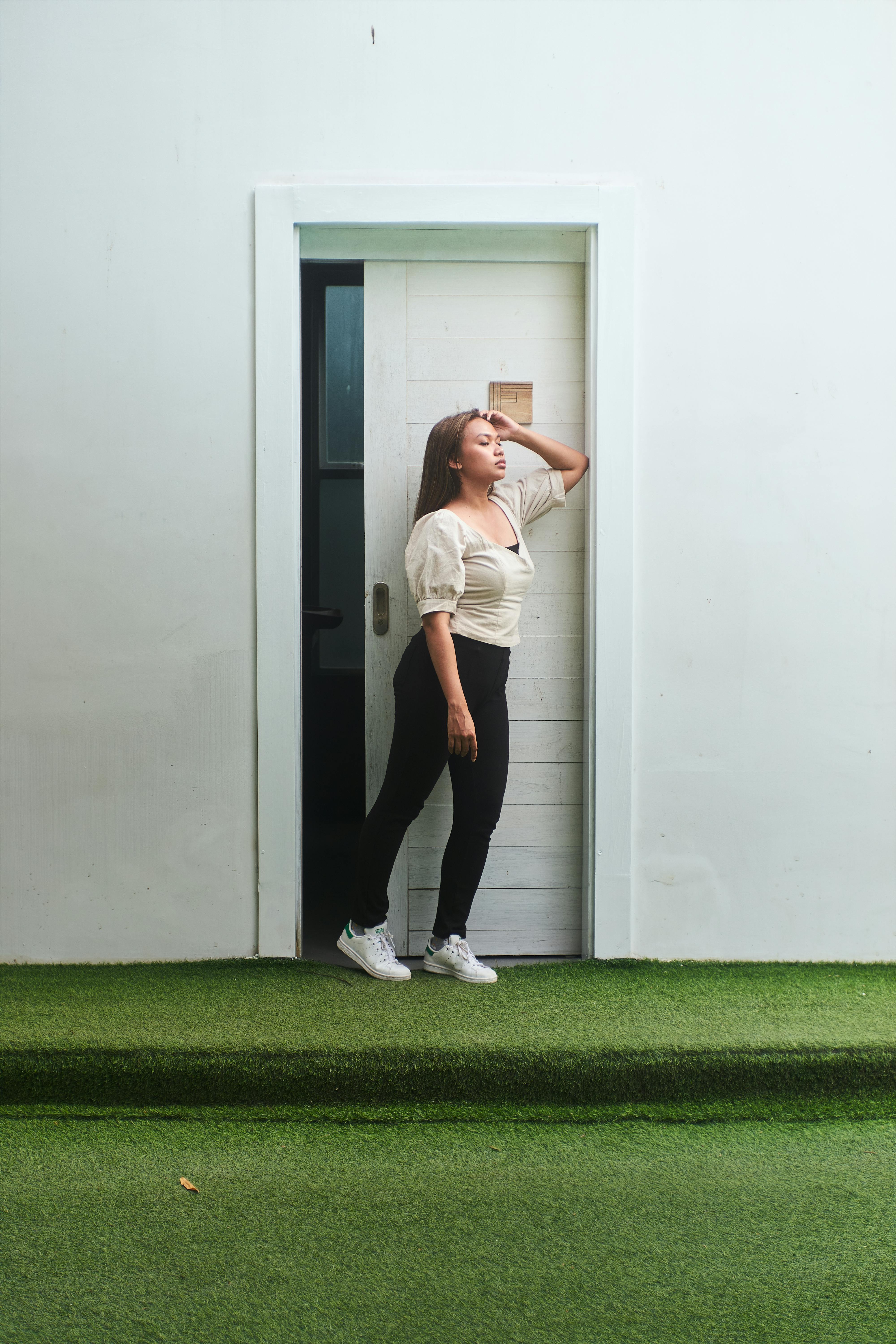 A Woman Standing at the Doorway · Free Stock Photo
