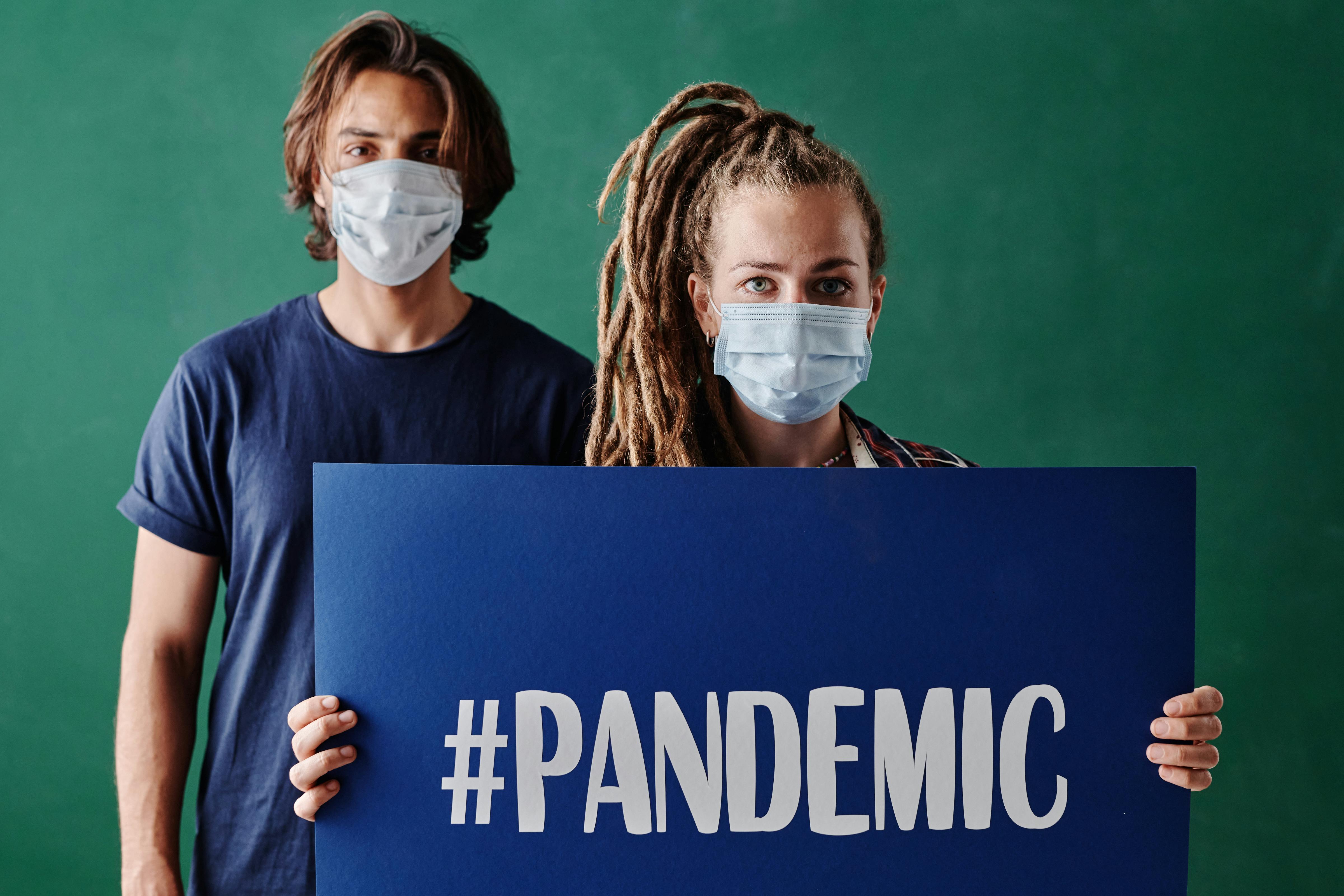 Woman Wearing Face Mask Holding Placard · Free Stock Photo