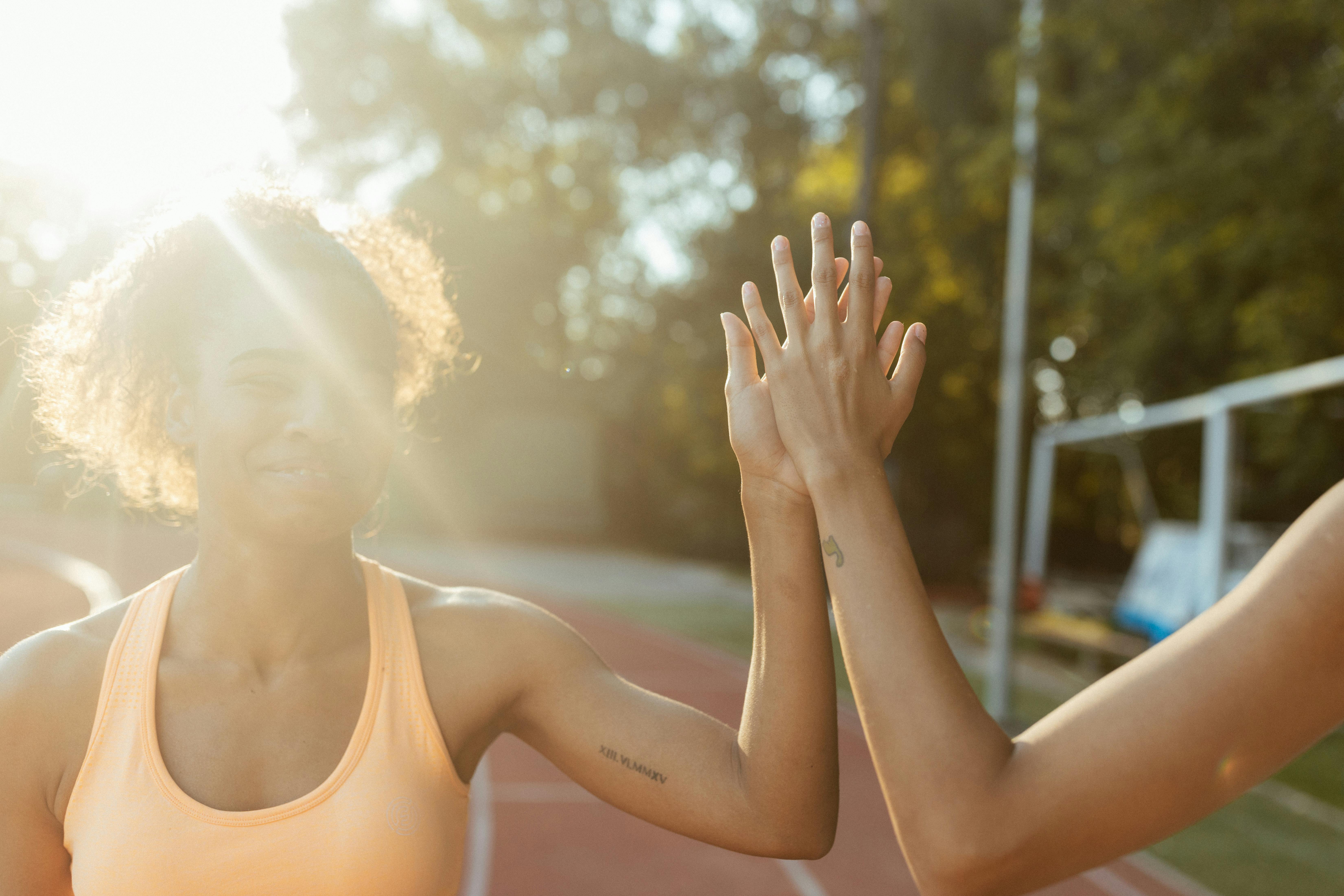 Smiling Woman Giving a High Five · Free Stock Photo