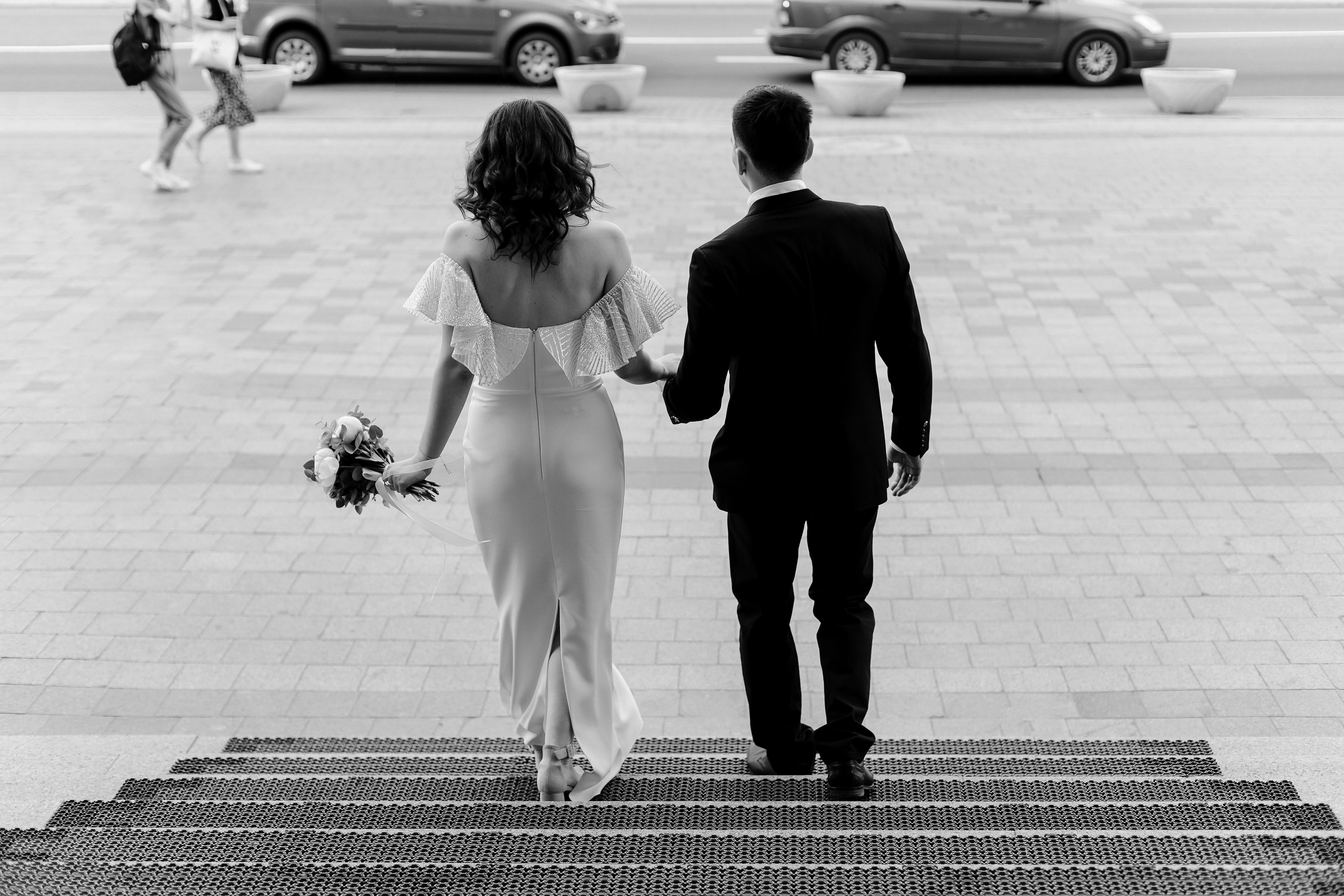 Grayscale Photo of a Romantic Couple Walking Down Stairs · Free Stock Photo