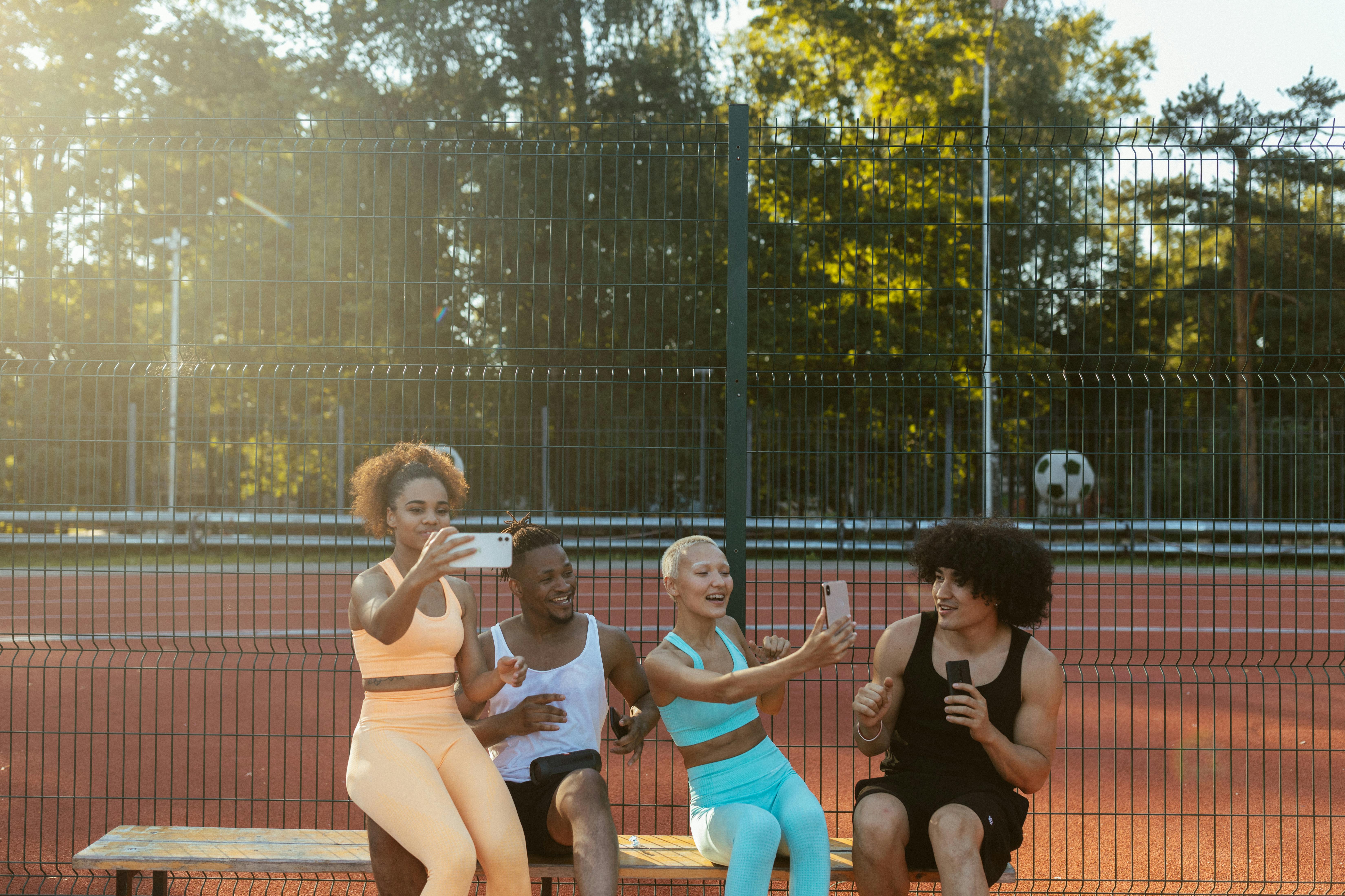 Group of Friends Sitting Together at a Bench · Free Stock Photo
