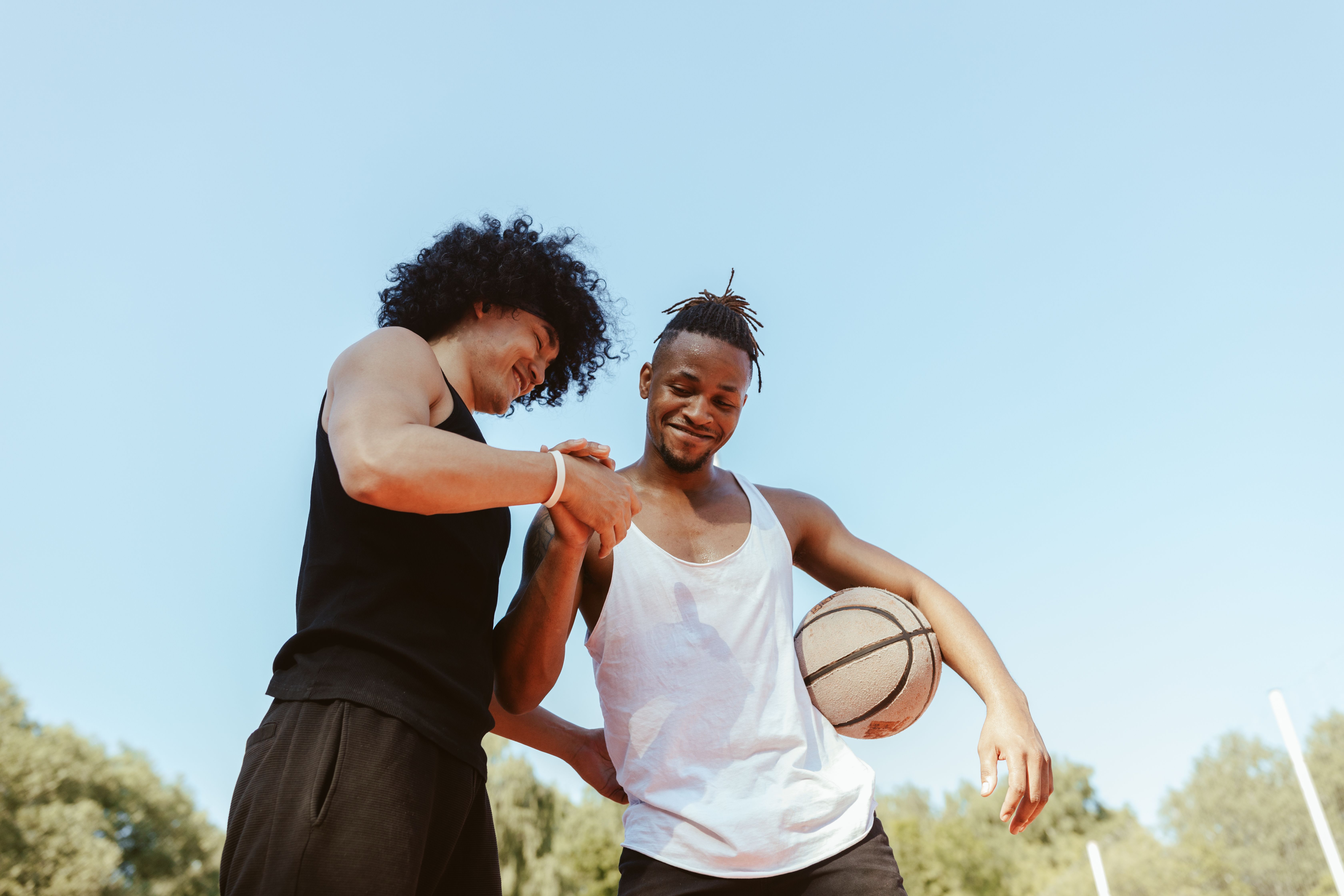 Low-Angle Shot of Two Men Playing Basketball · Free Stock Photo