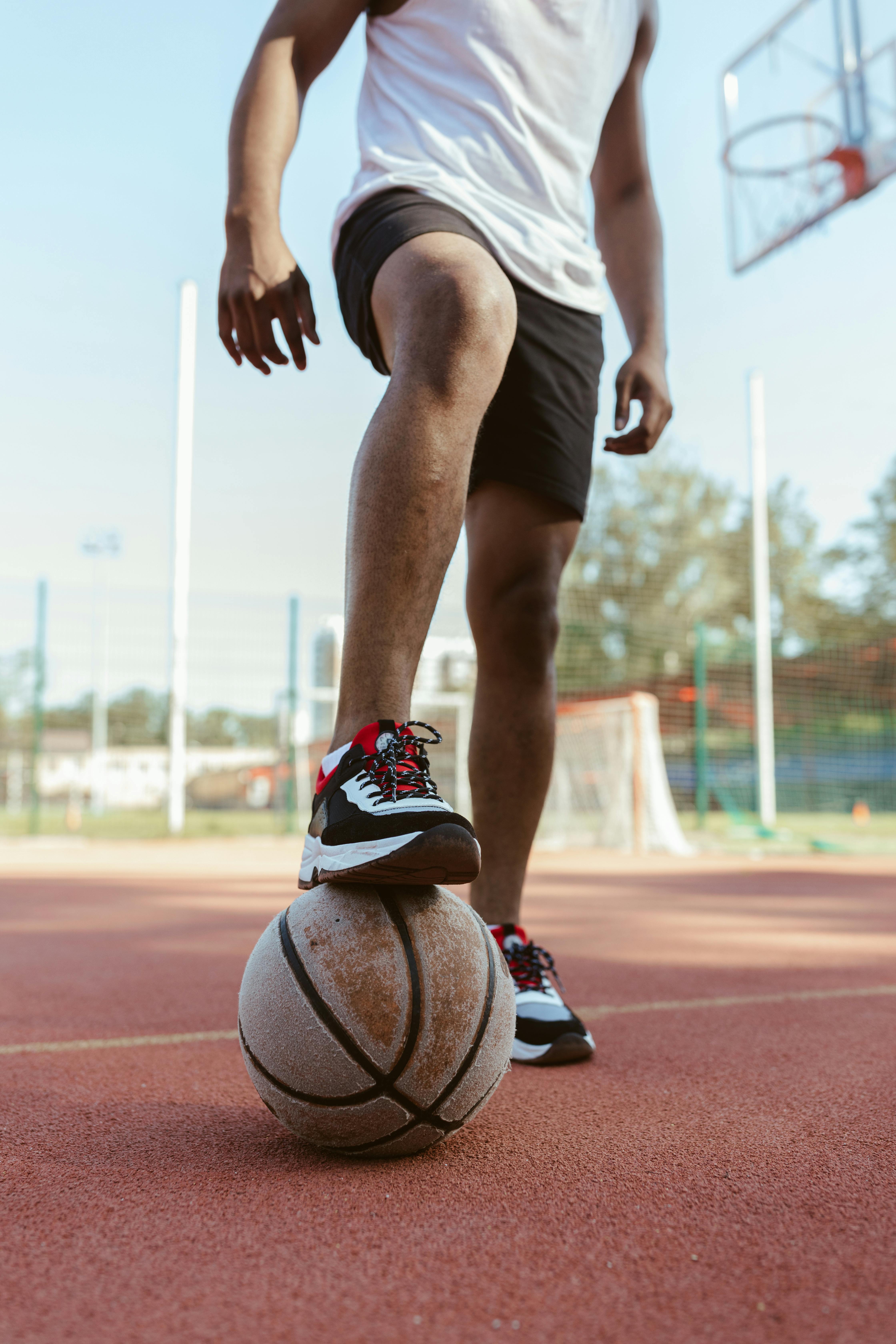 A Person Stepping on a Basketball · Free Stock Photo