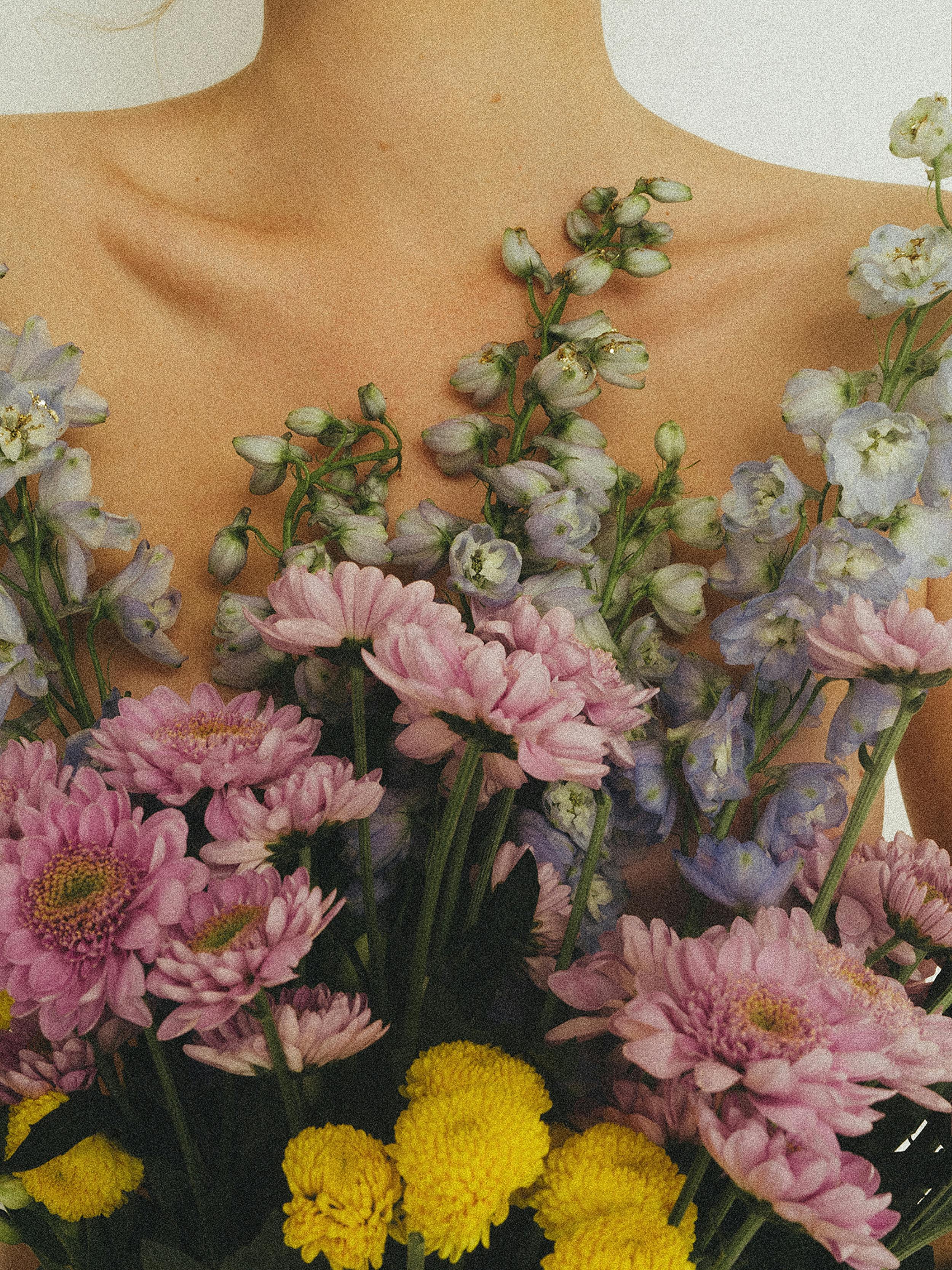 a Bunch of Flowers on a Woman's Chest · Free Stock Photo