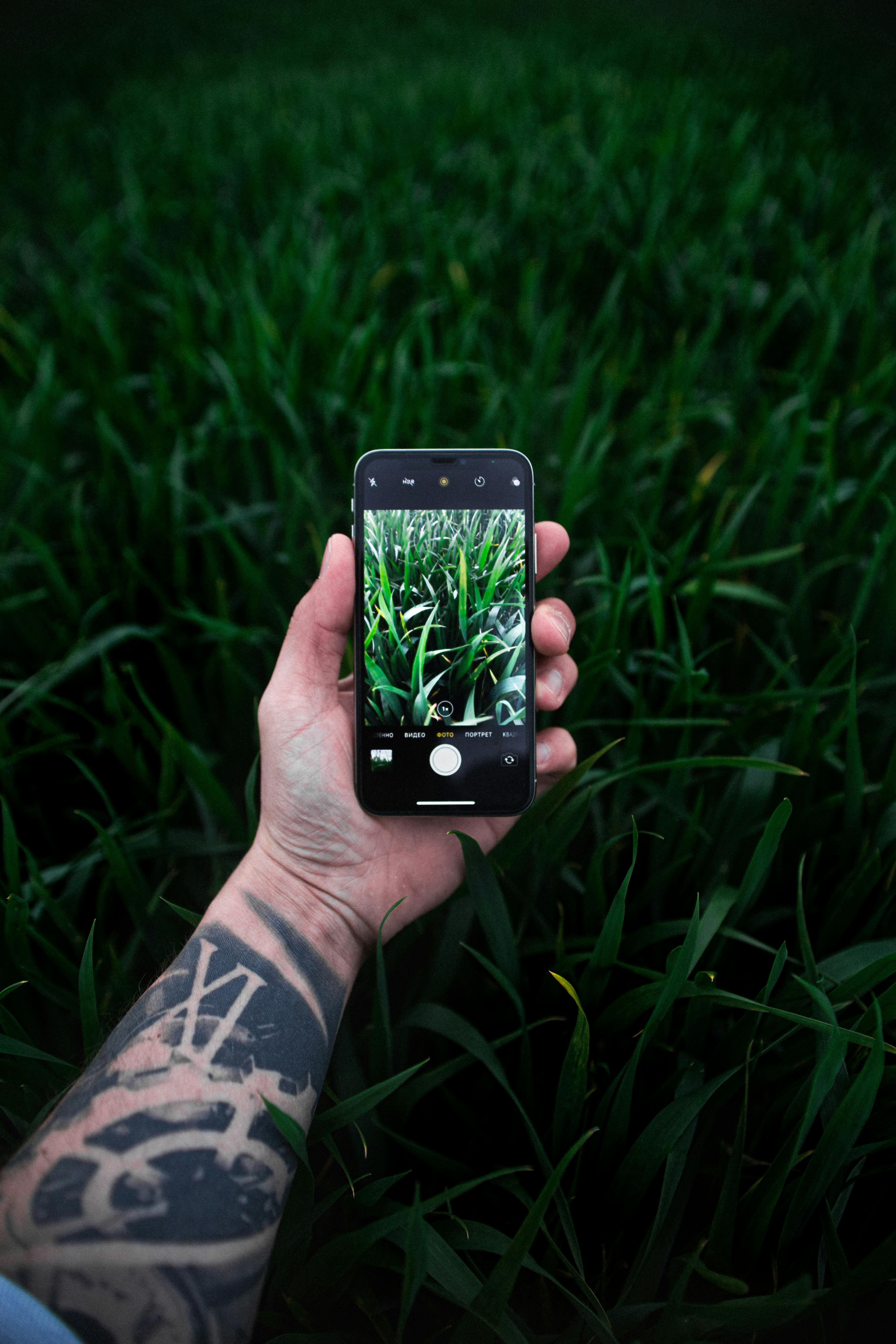 Selective Focus Photography of Person Using Iphone X · Free Stock Photo