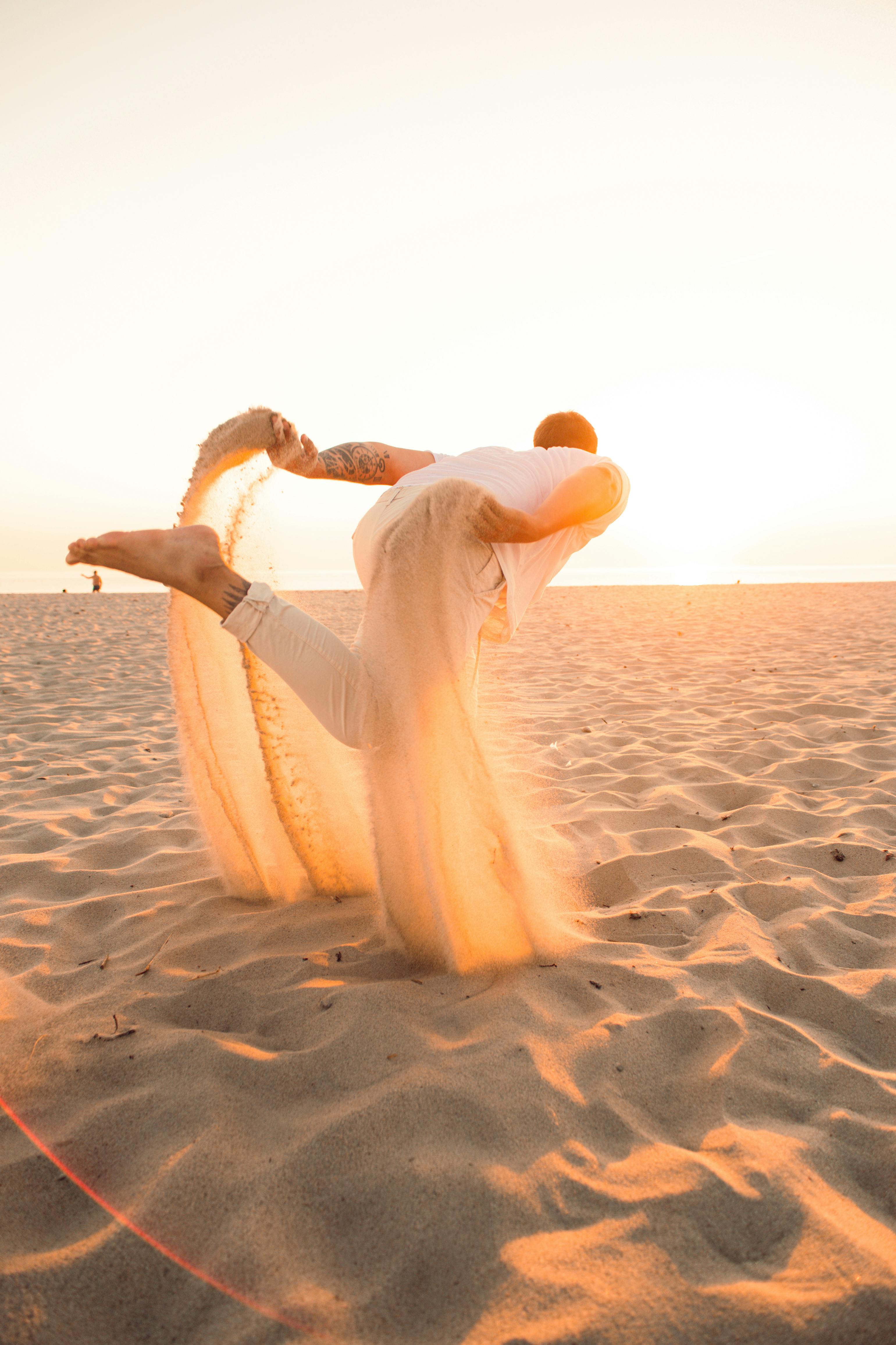 Man Throwing Sand on the Beach · Free Stock Photo