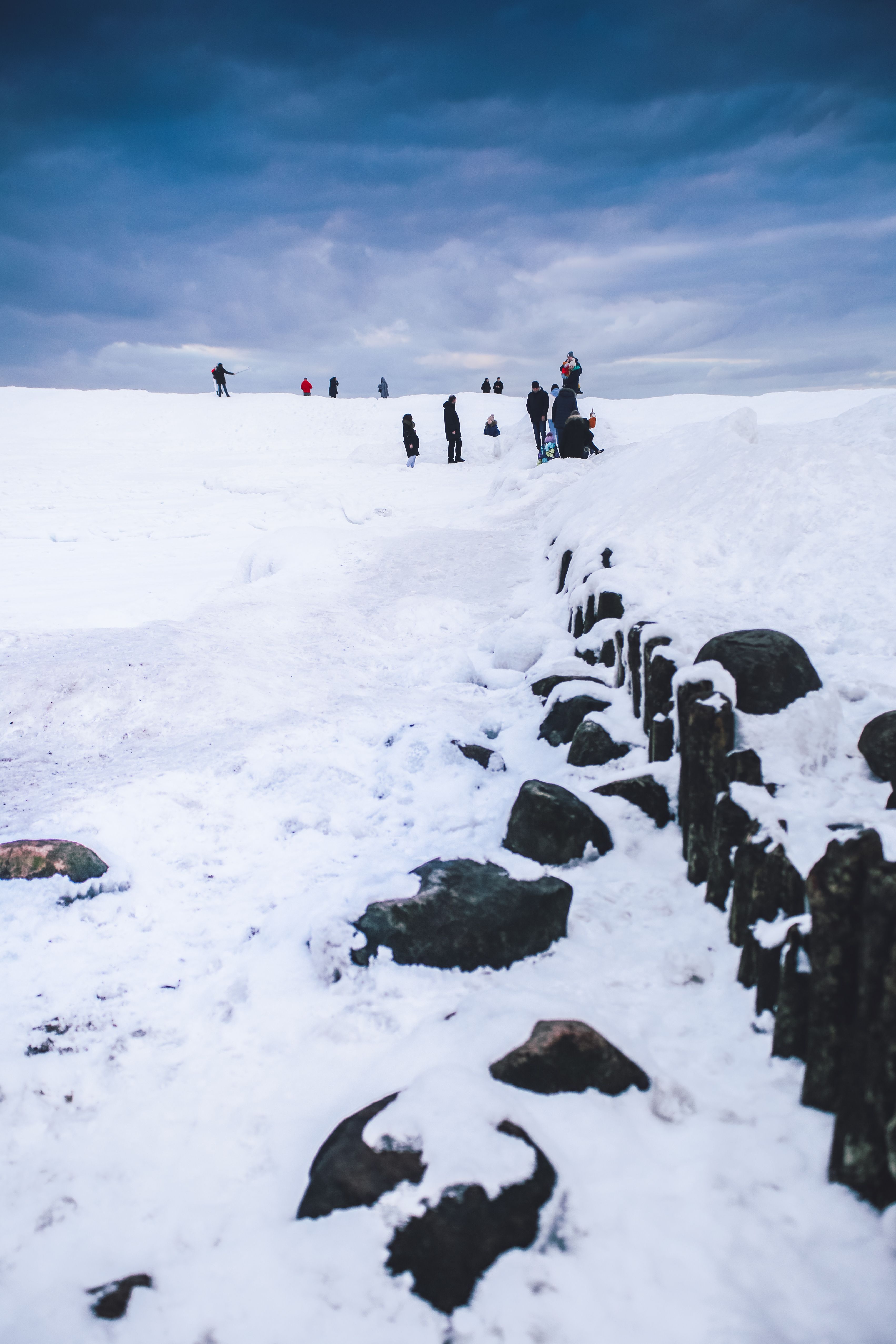 People Standing on Snow with Footprints · Free Stock Photo