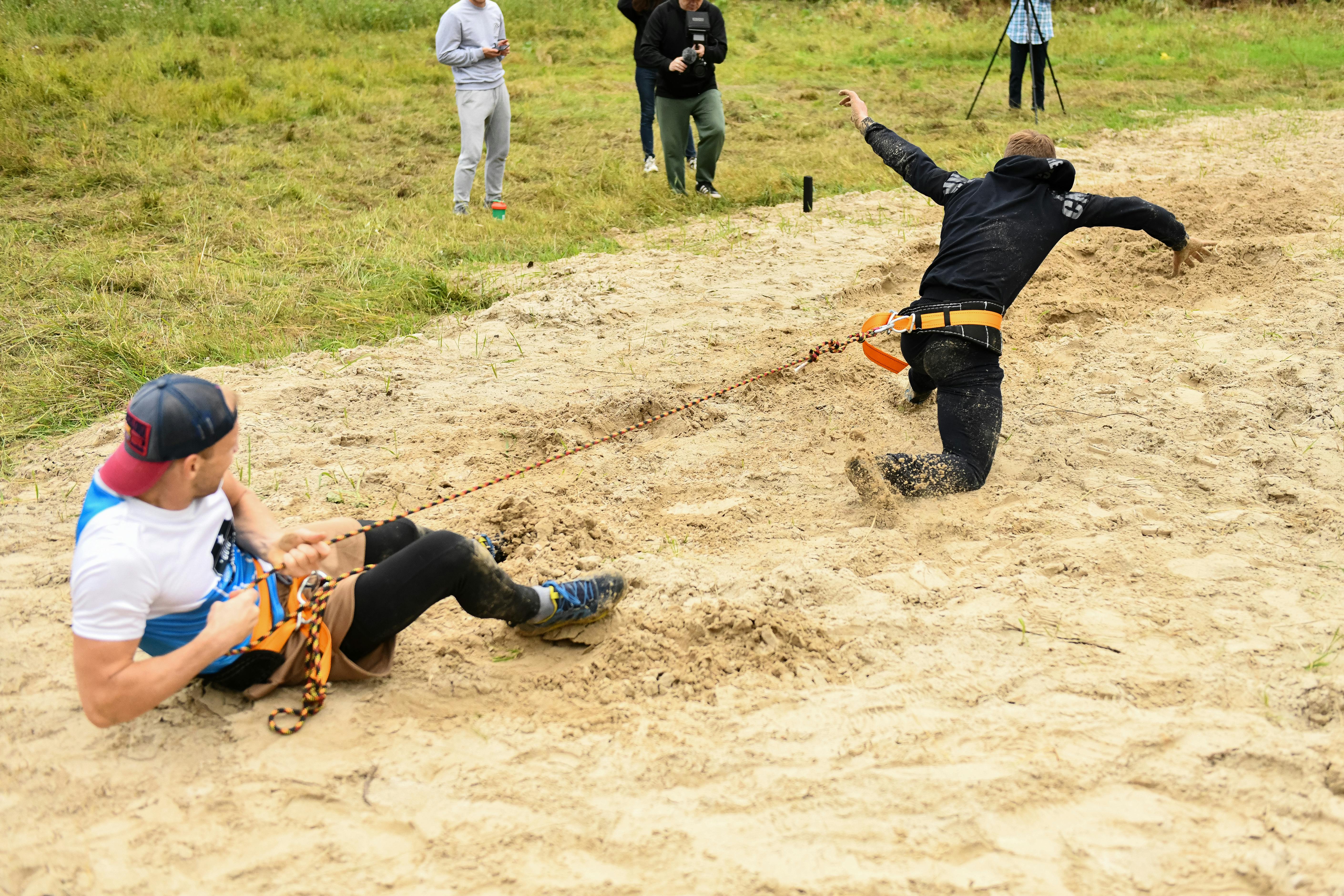 A Man Pulling another Man Tied to a Harness · Free Stock Photo