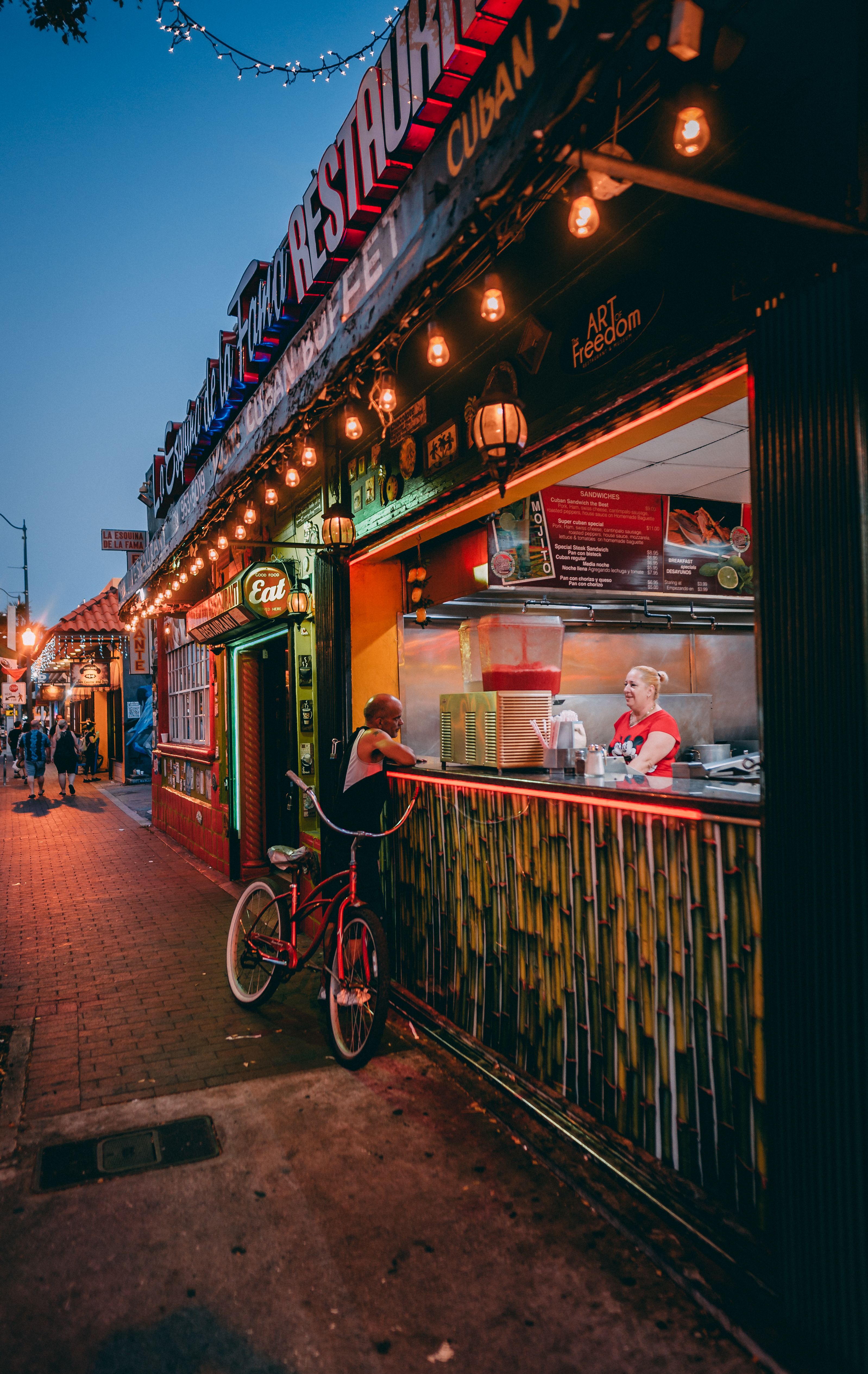 A Man Standing Beside the Food Stall · Free Stock Photo