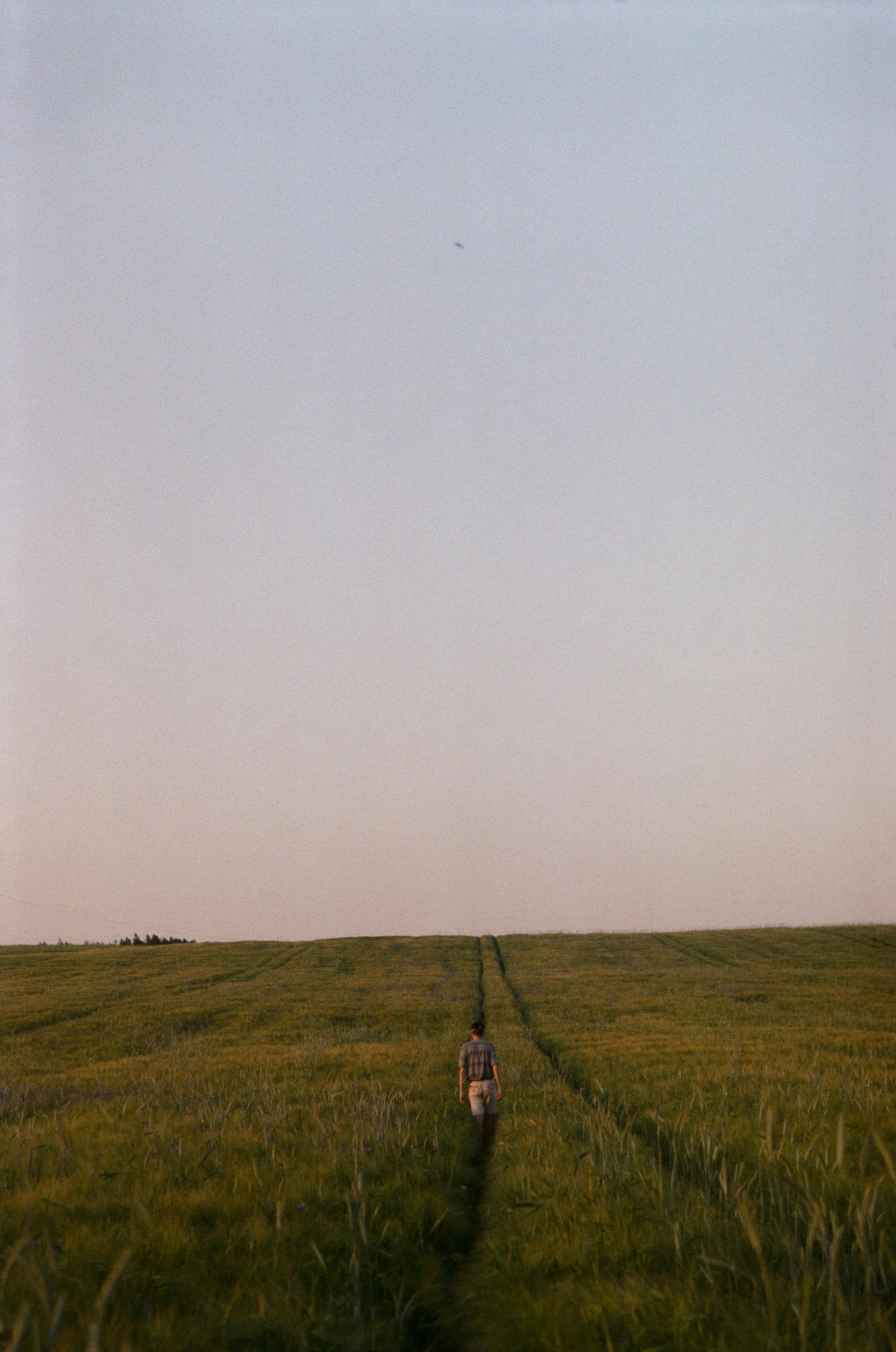 A Man Walking on a Field · Free Stock Photo