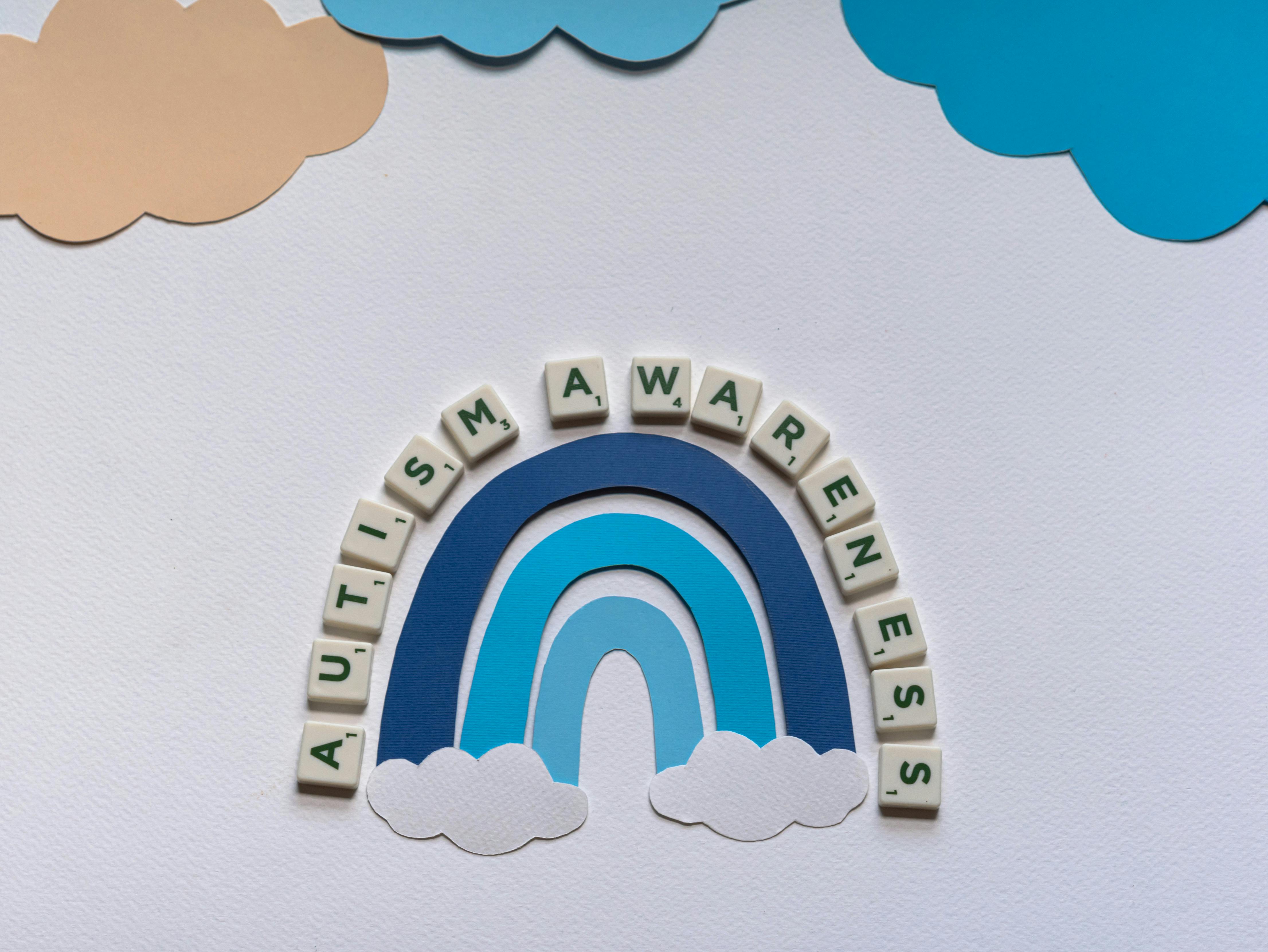 Scrabble Tiles and Paper Cutouts on a White Background · Free Stock Photo