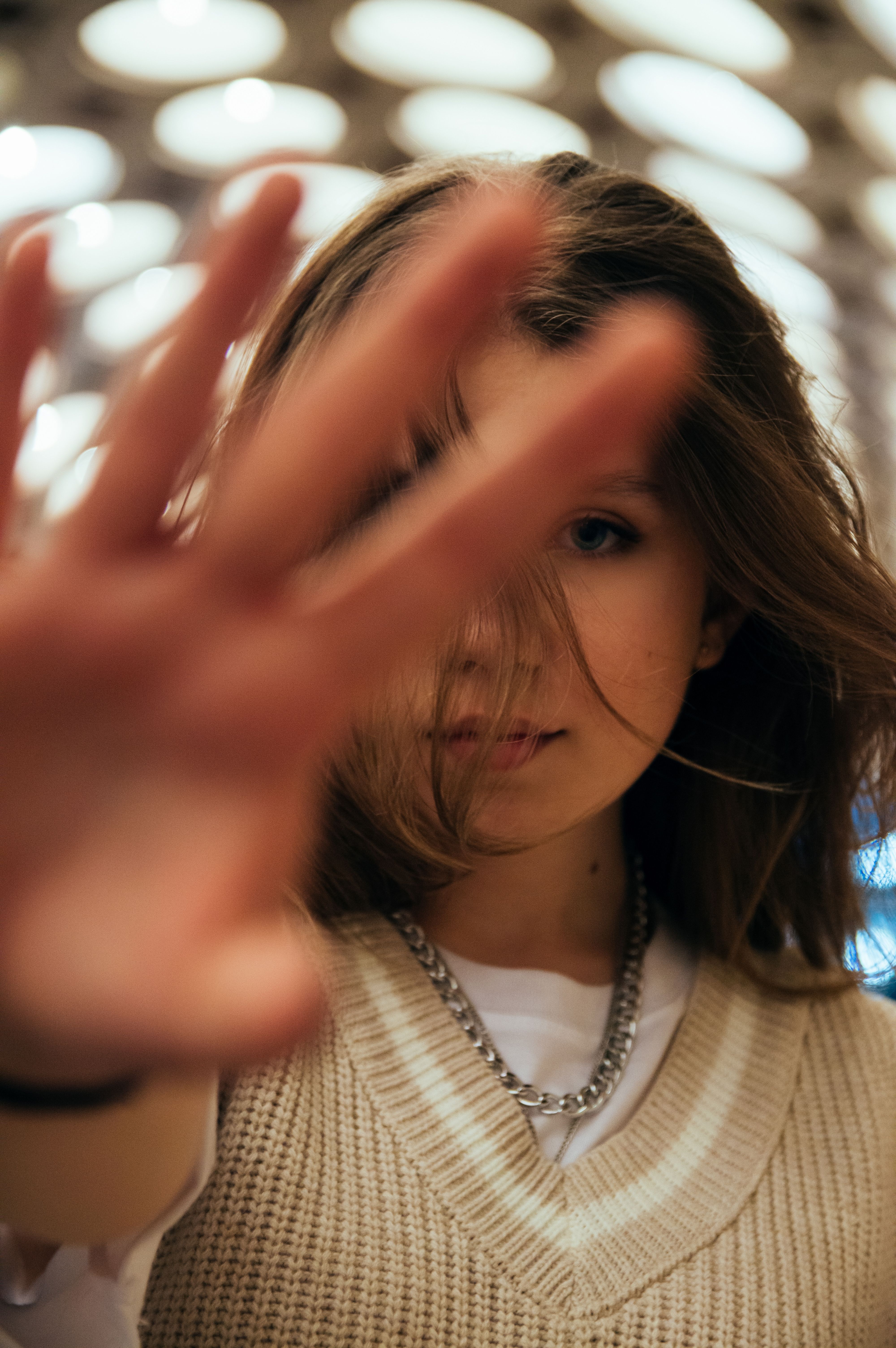 Beautiful Woman Covering the Camera with her Hand · Free Stock Photo