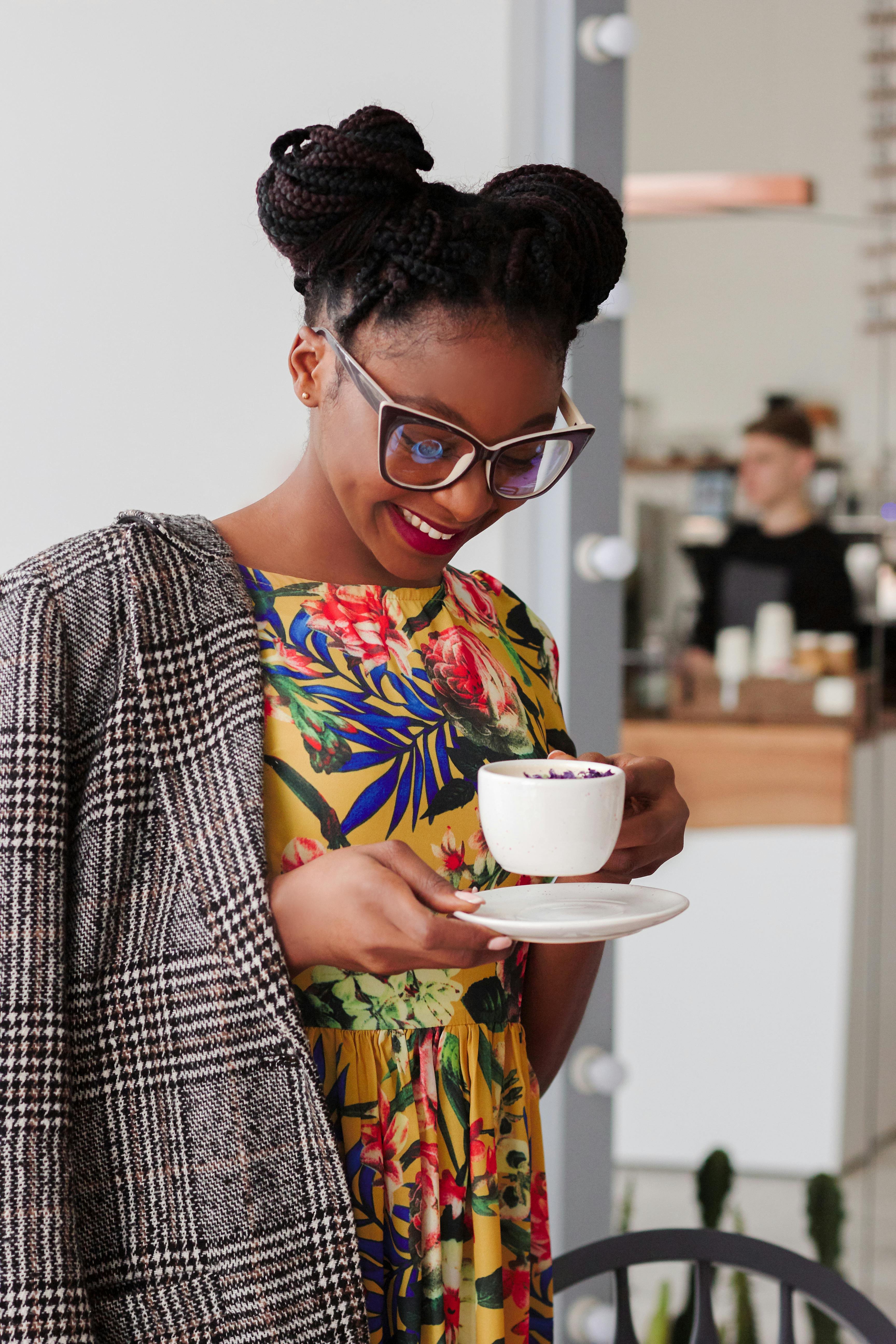 Woman Holding Teapot Near Table · Free Stock Photo