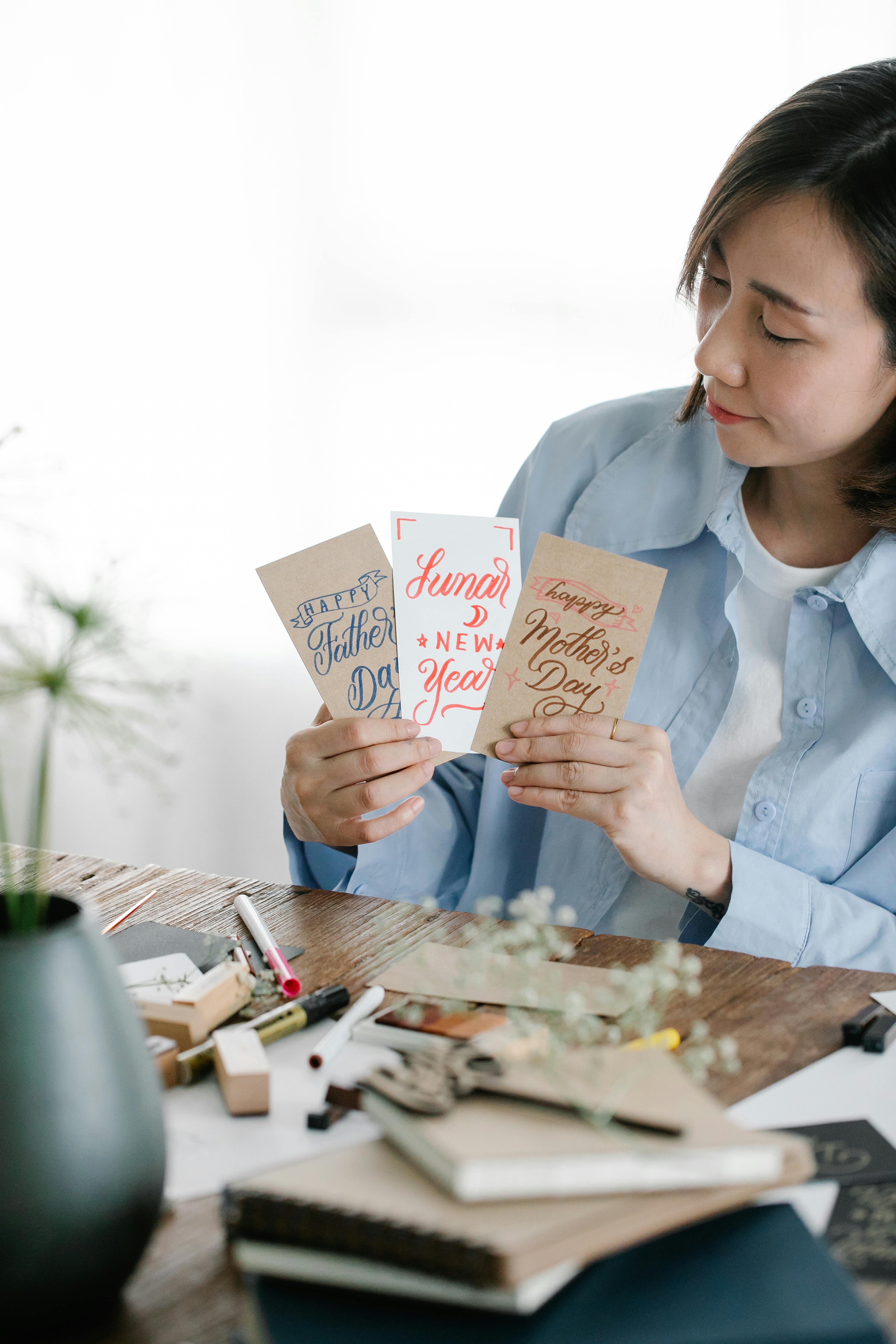 Woman Holding Calligraphy Cards · Free Stock Photo
