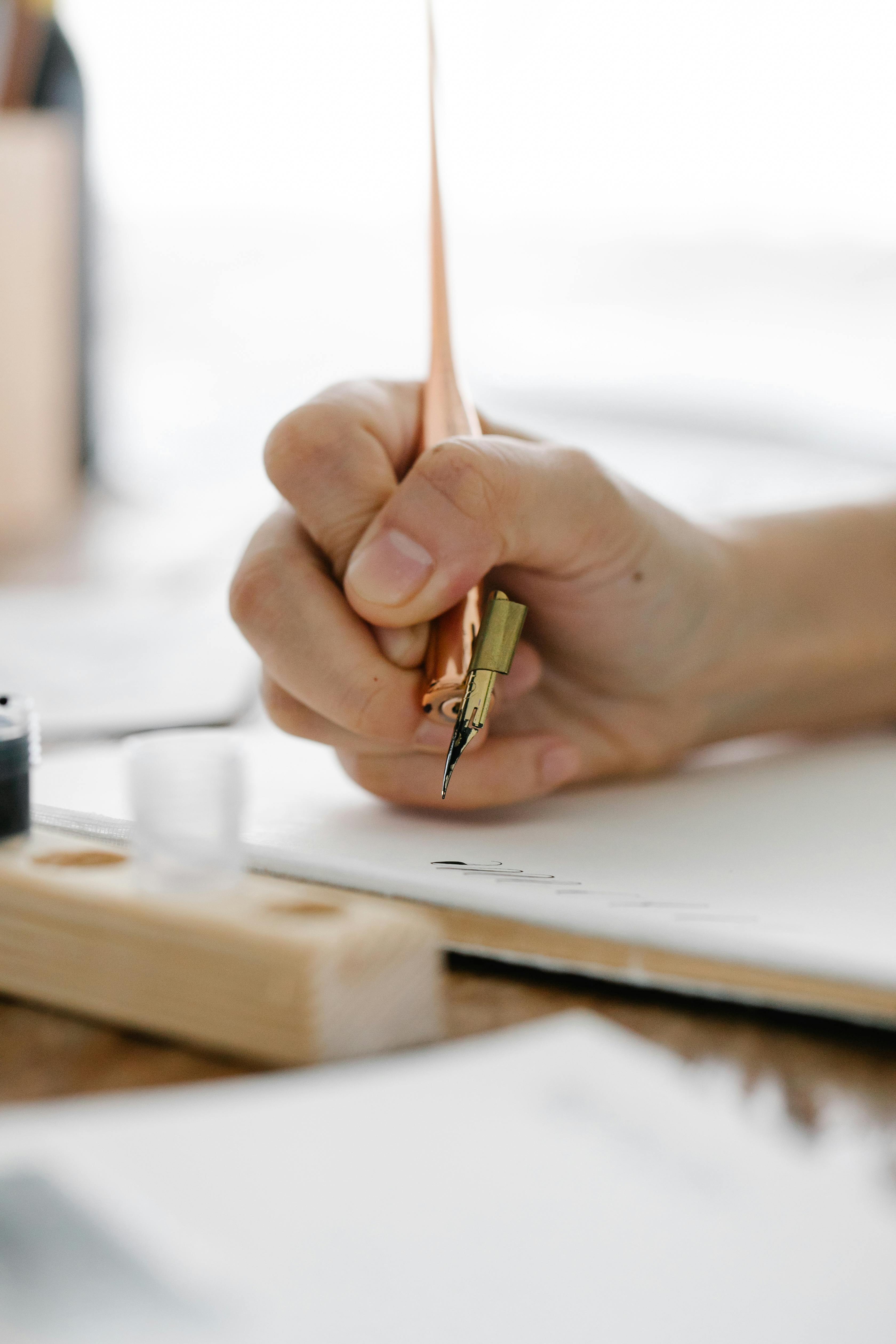 Close-up of Person Writing with an Ink Pen · Free Stock Photo