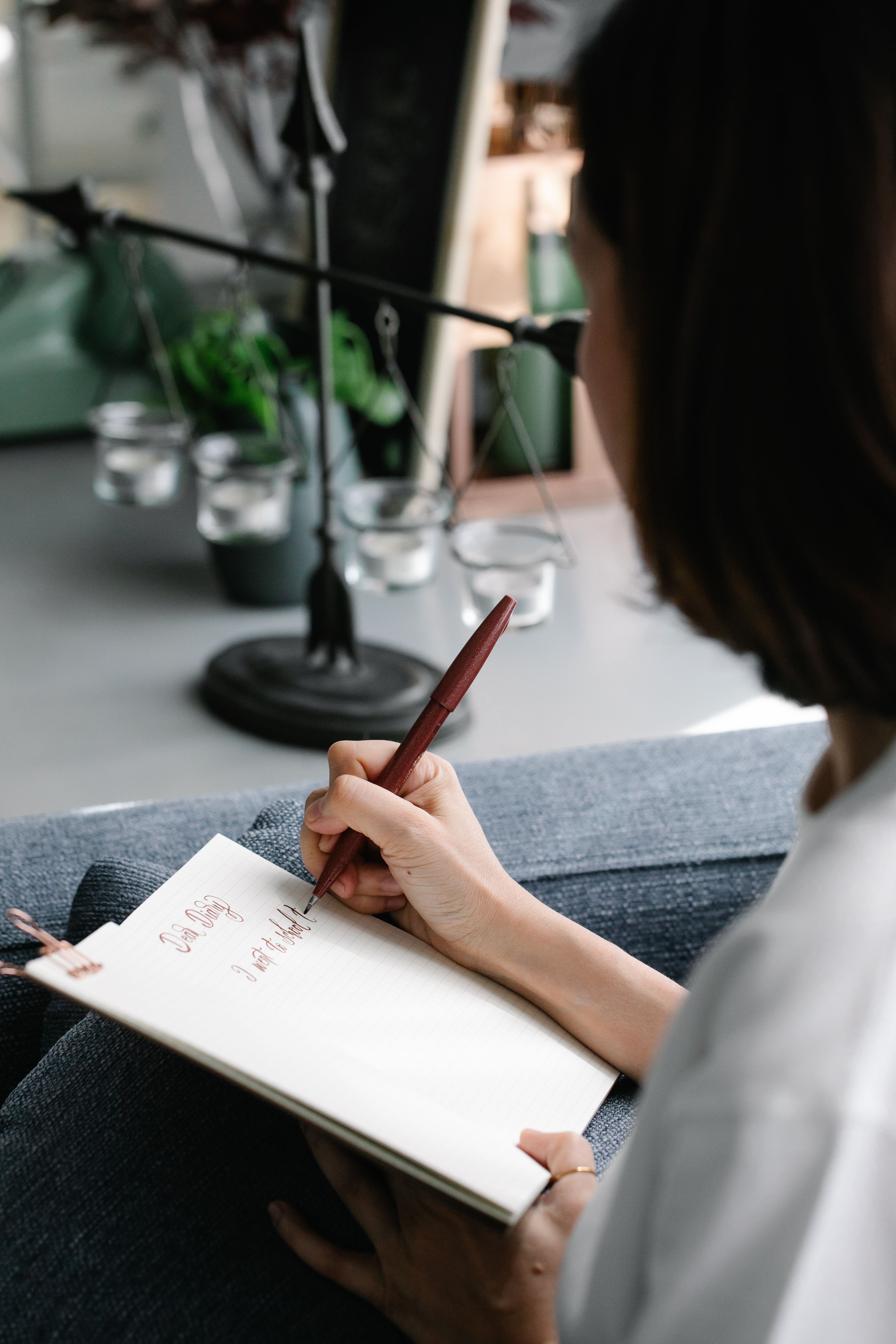 Person Holding a Pen and Notebook · Free Stock Photo