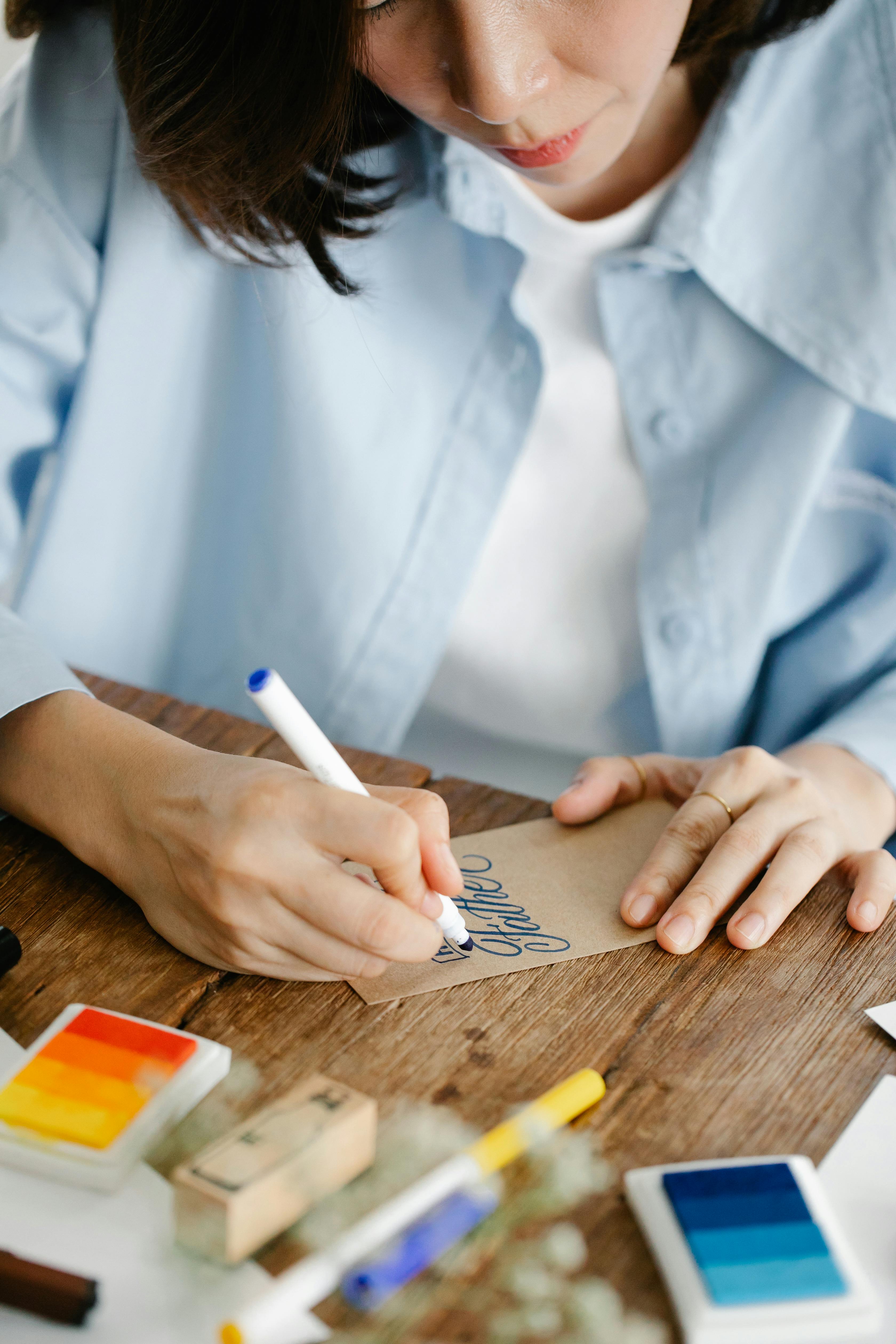 Woman Writing on Cardboard · Free Stock Photo