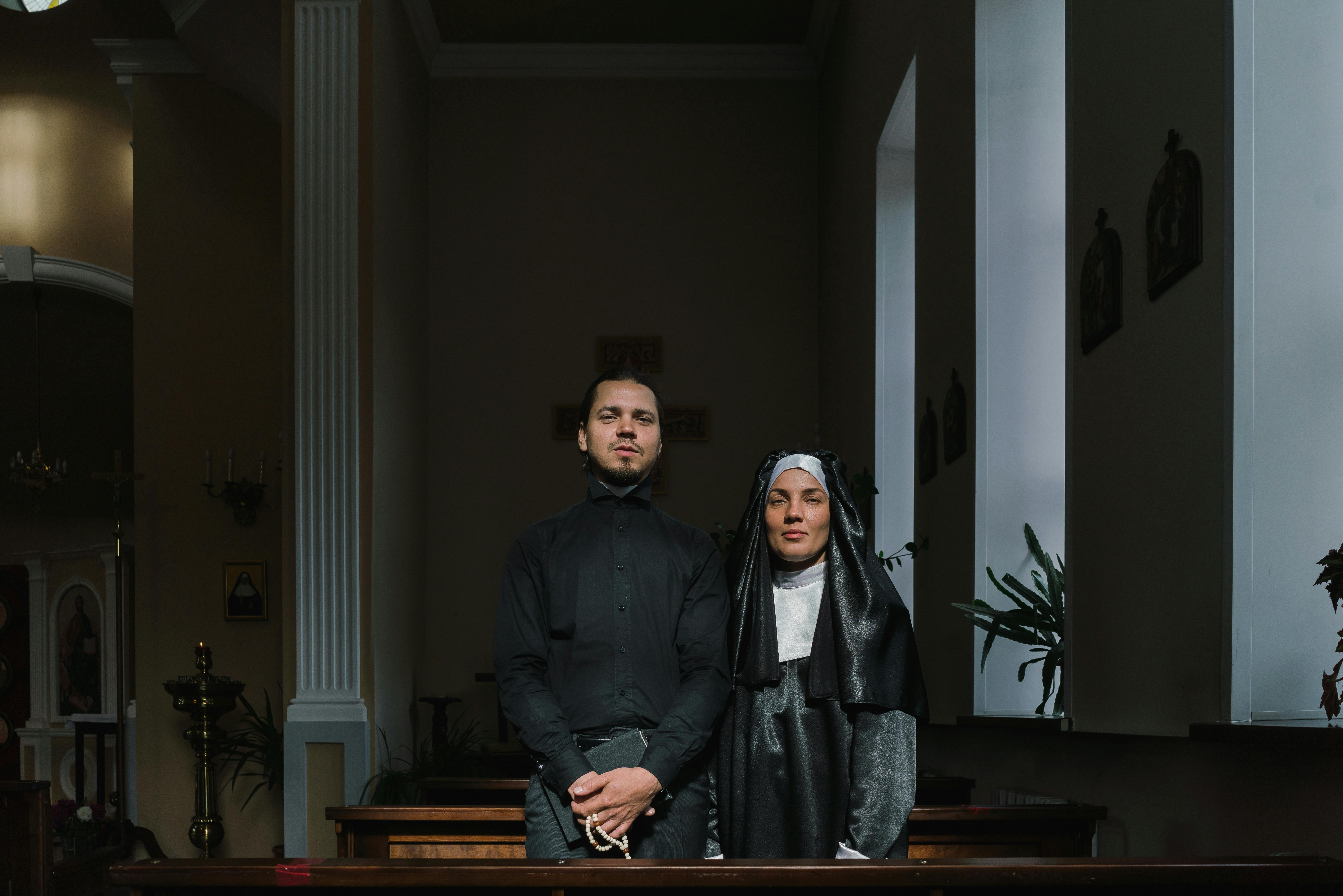 Man and a Nun Standing Together Inside a Church · Free Stock Photo