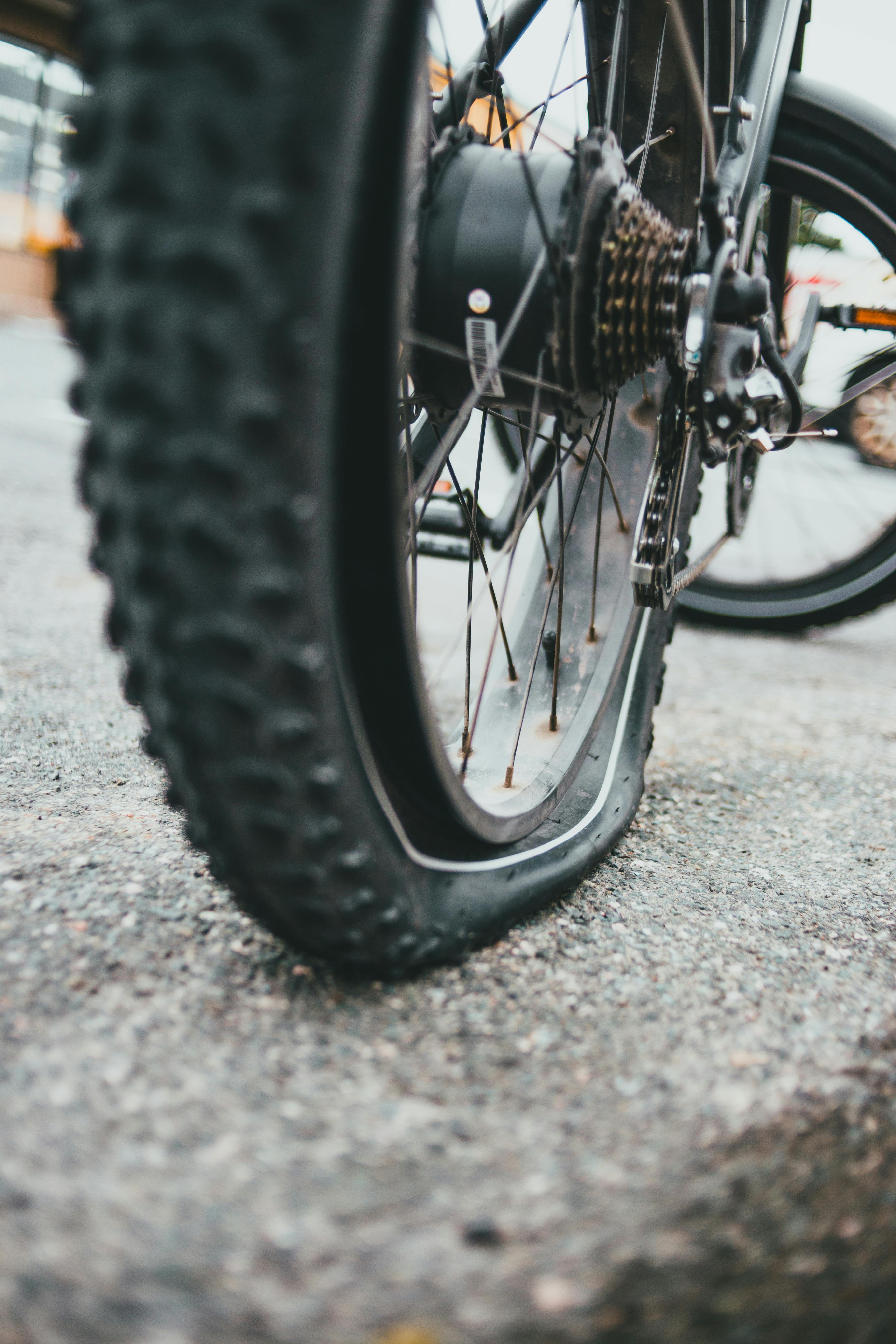 Close-up of a Flat Tyre in a Bicycle · Free Stock Photo