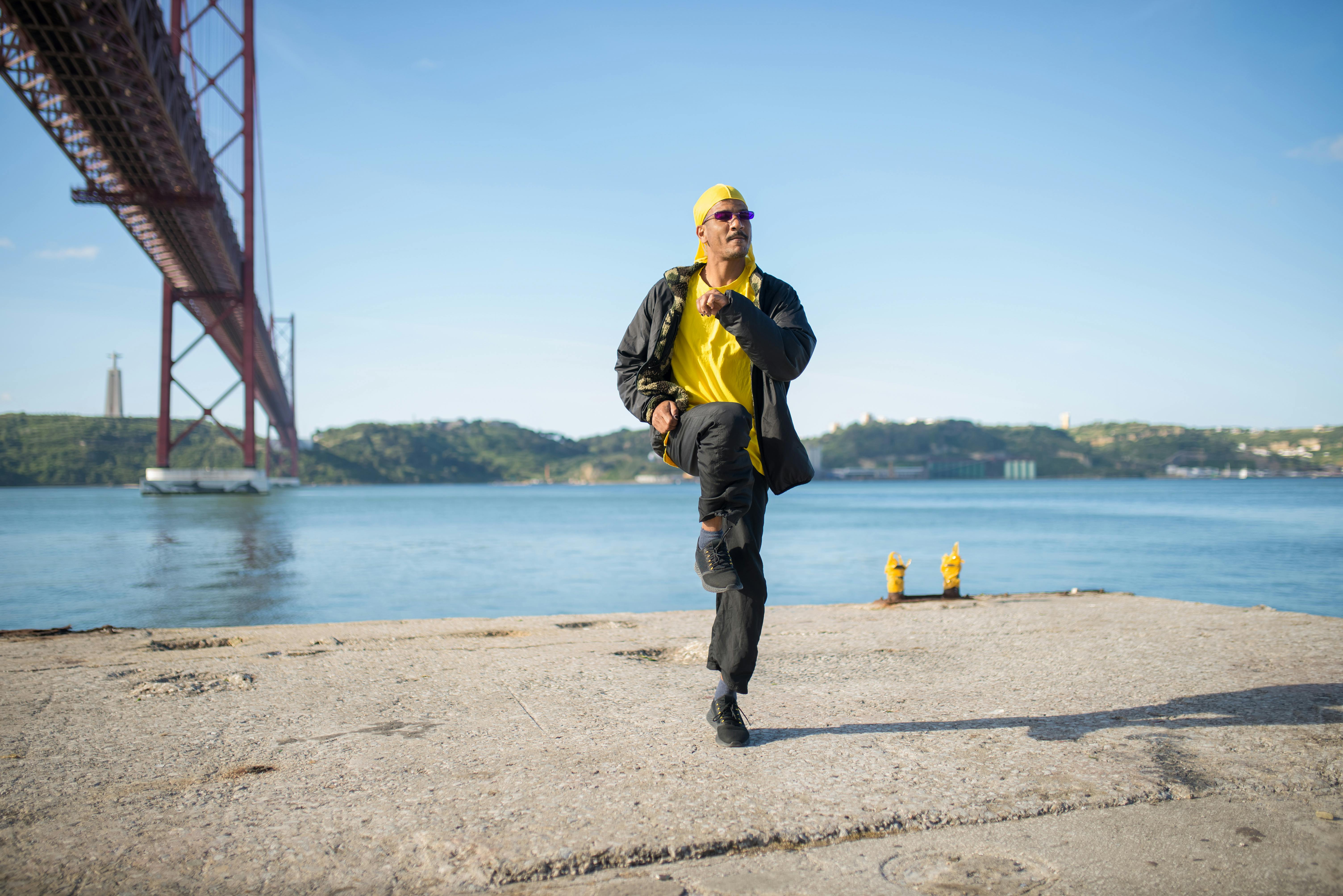 Man in Yellow Sweater and Black Pants Dancing · Free Stock Photo