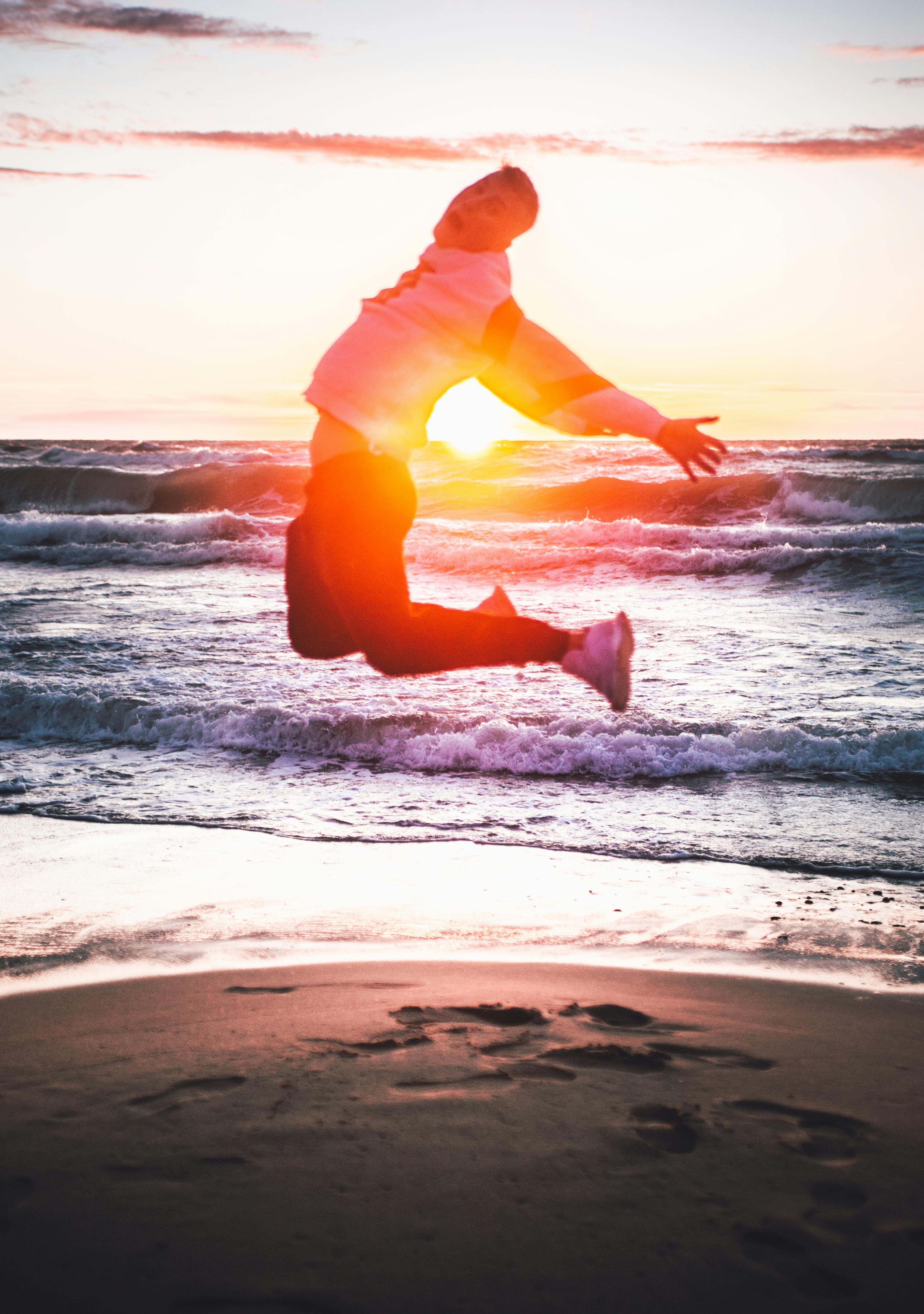 Jump Shot Photo of Man on Beach · Free Stock Photo