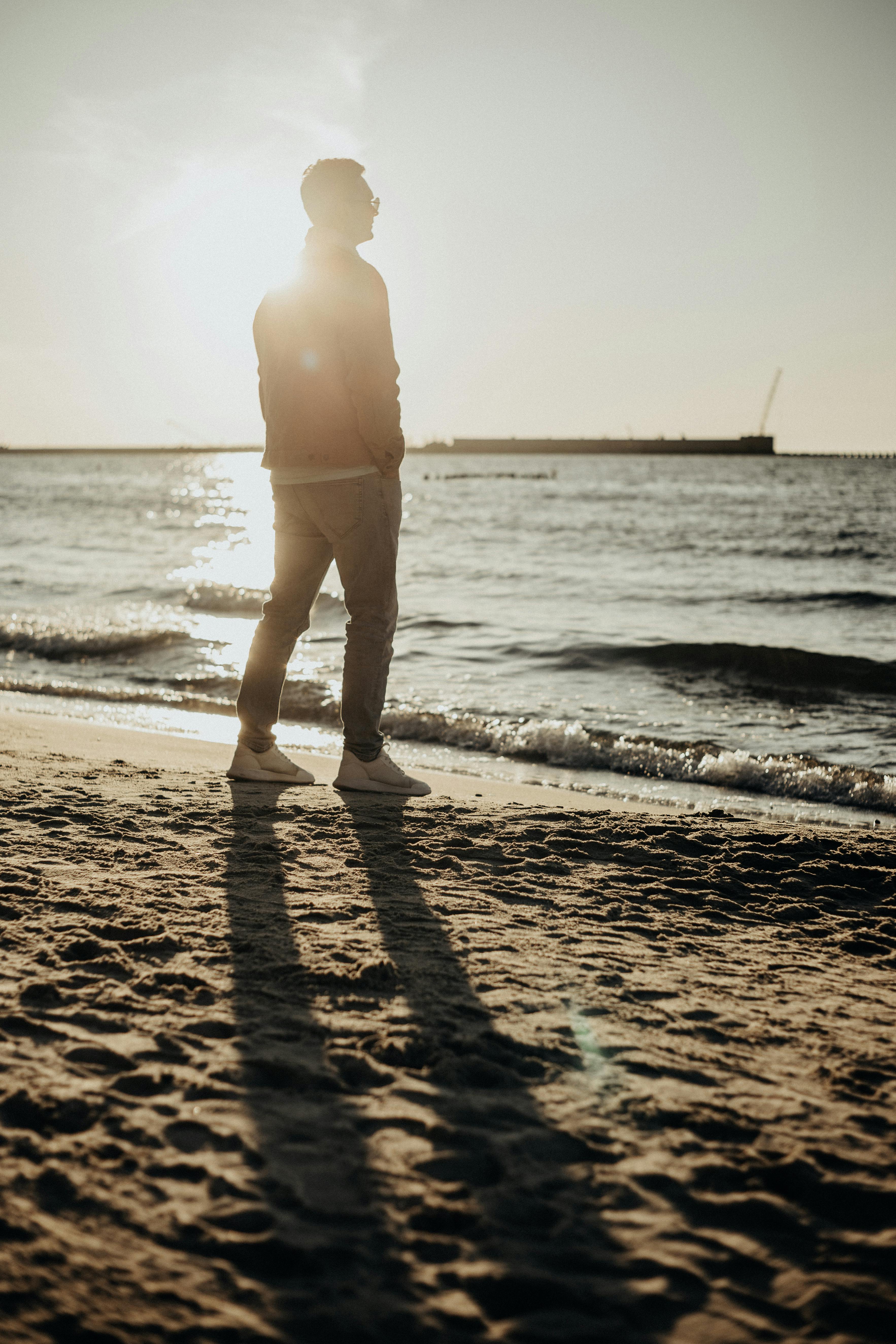 A Man on the Shore of a Beach · Free Stock Photo