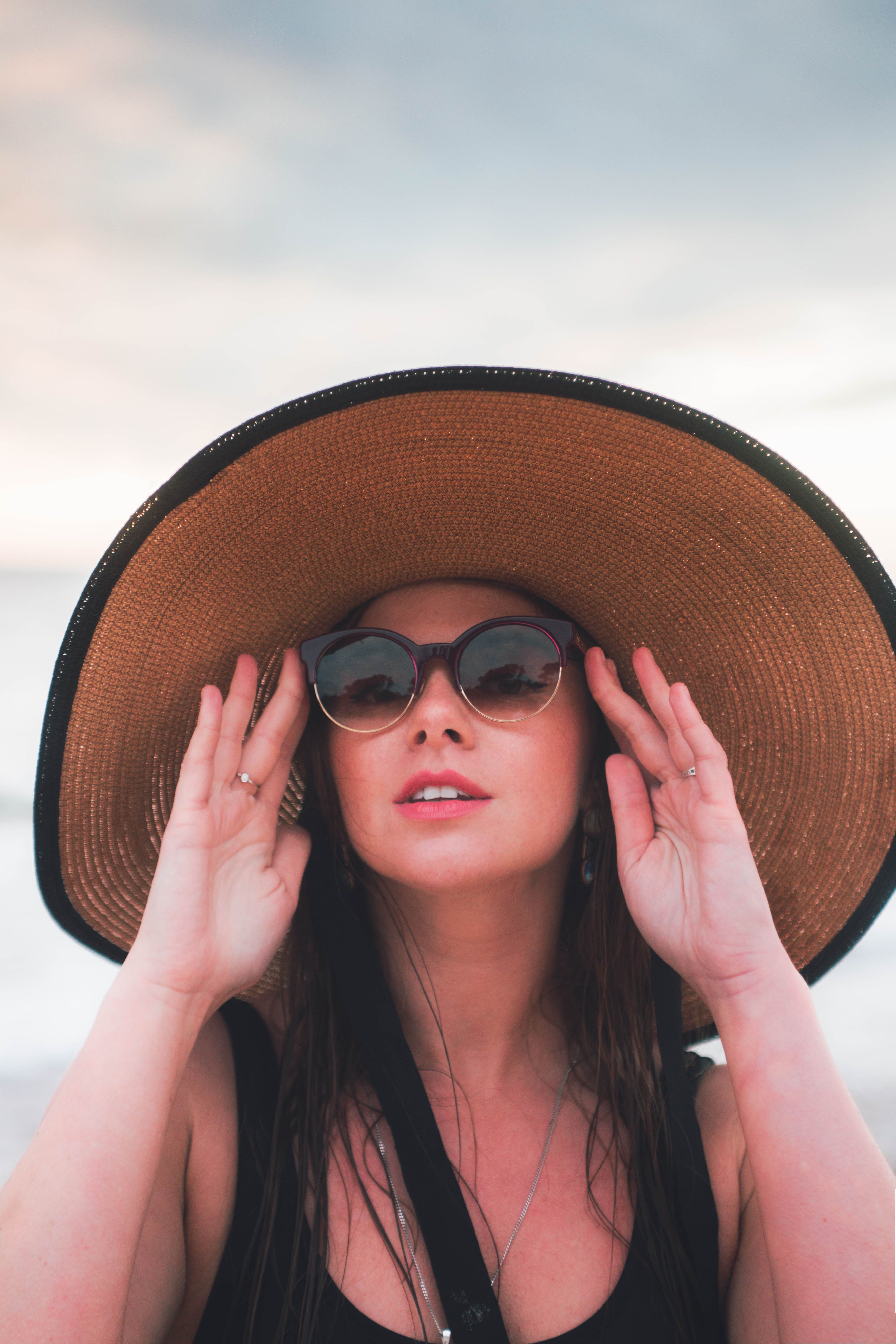 Portrait of Woman Shielding Face from Sun · Free Stock Photo